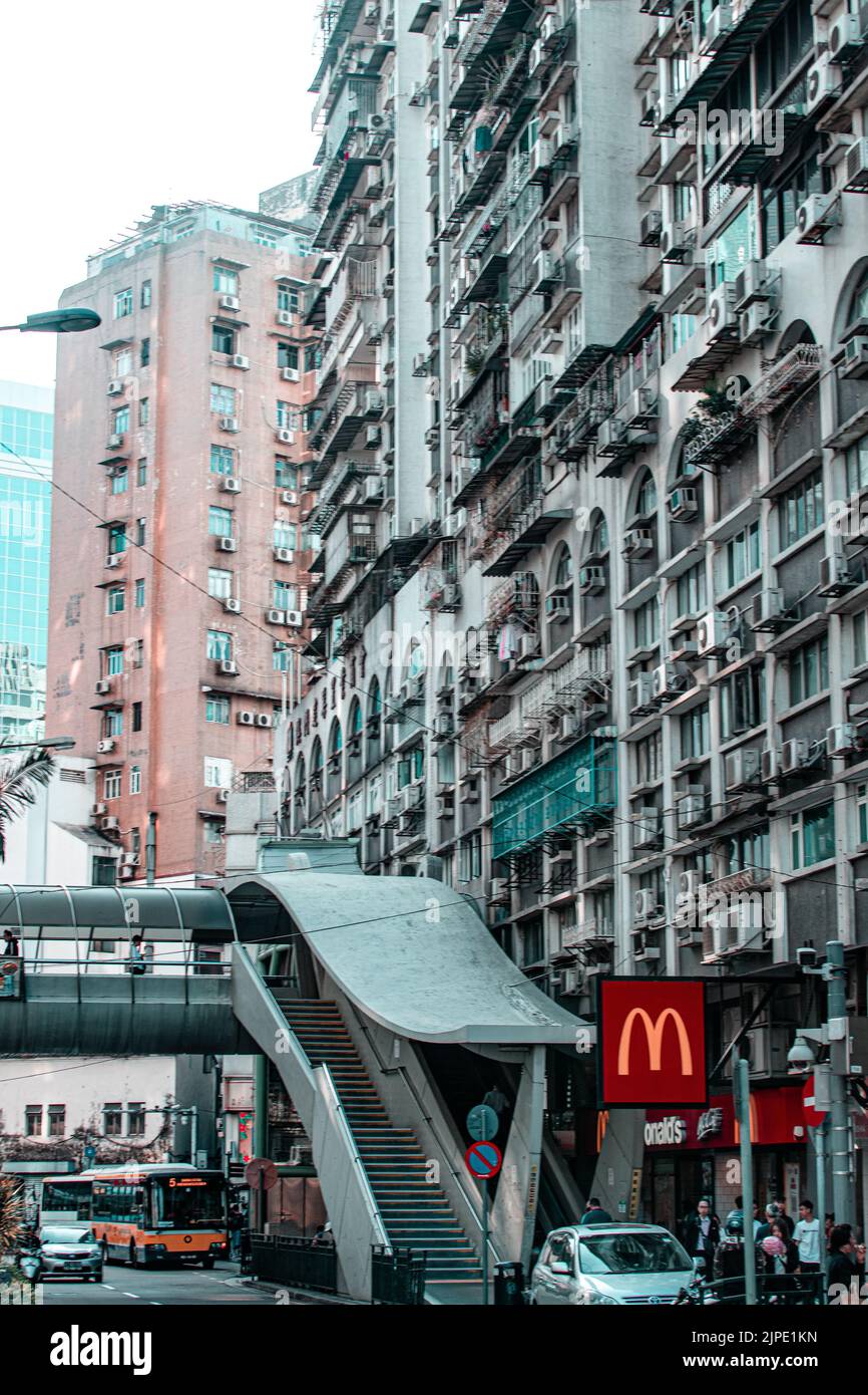 The Macao's streets surrounded by skyscrapers, cars, and a public bus ...