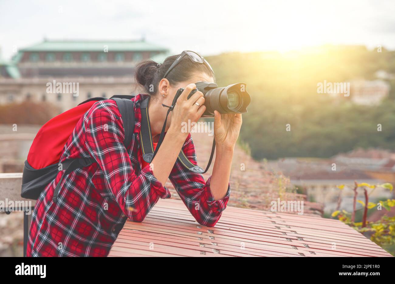 A woman photographer makes a photo while traveling Stock Photo - Alamy