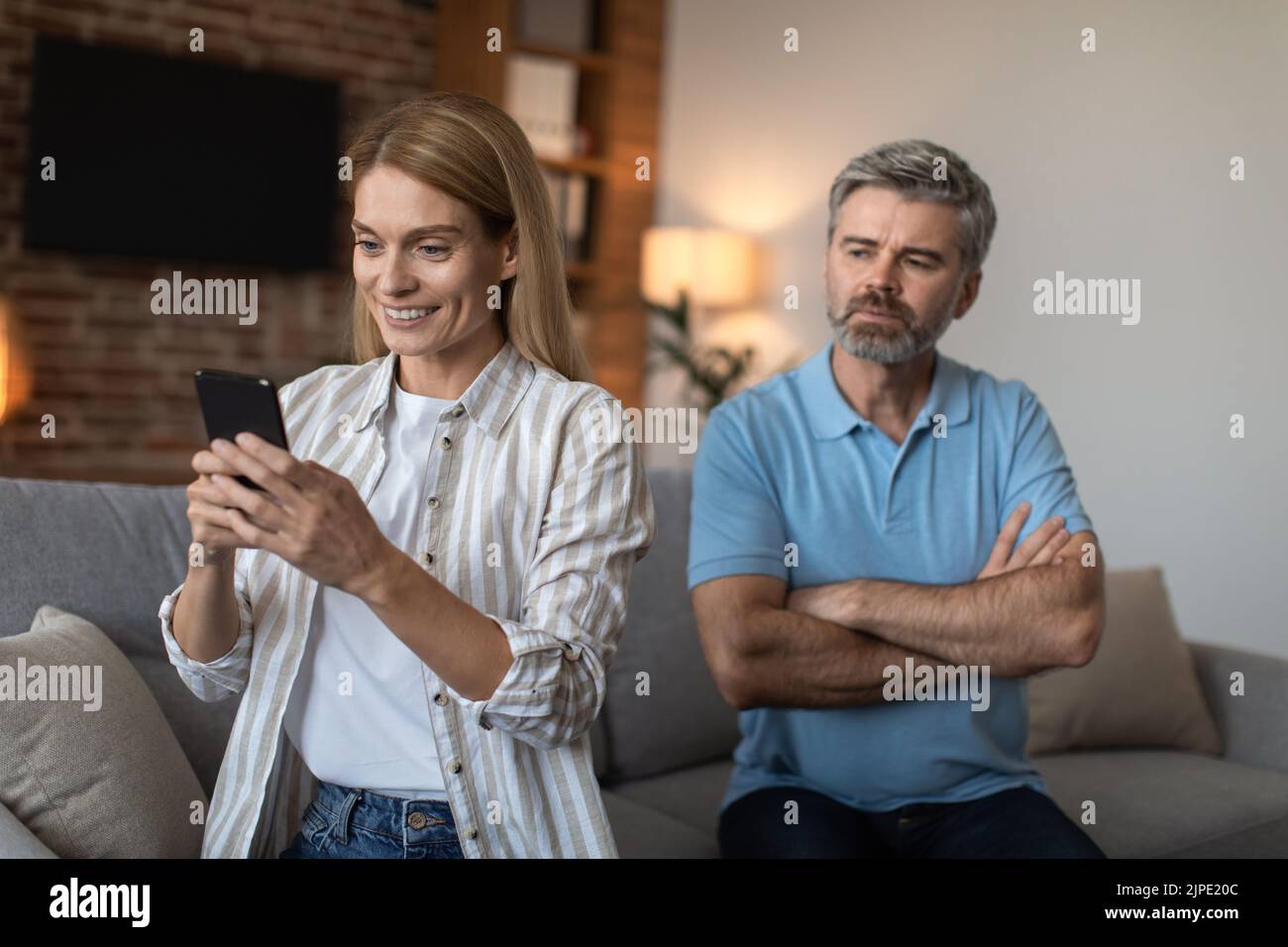 Mature woman angry husband phone hi-res stock photography and images ...