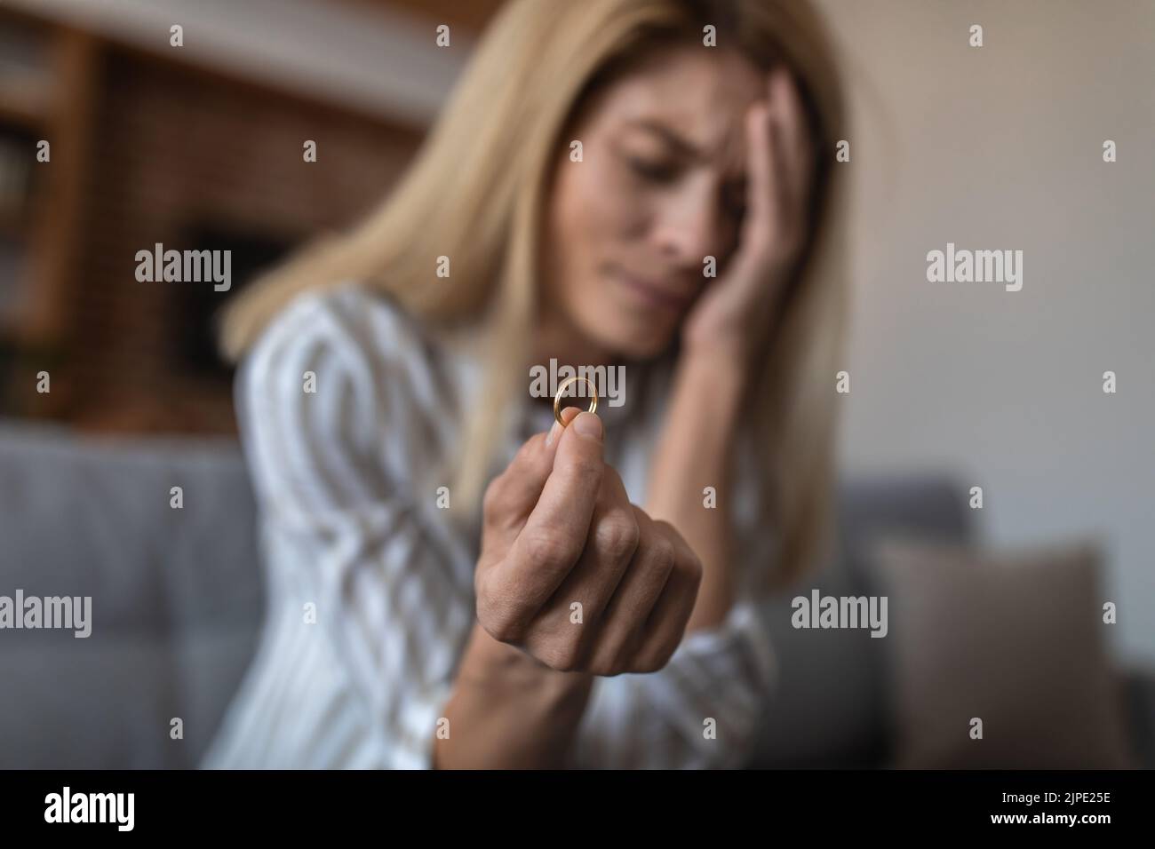 Unhappy crying adult caucasian wife gives back ring to camera ...