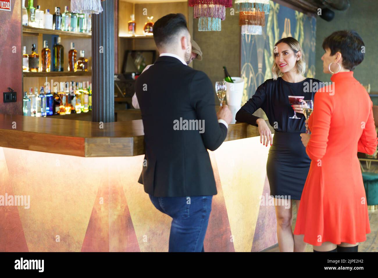 Company of elegant friends gathering in bar Stock Photo - Alamy