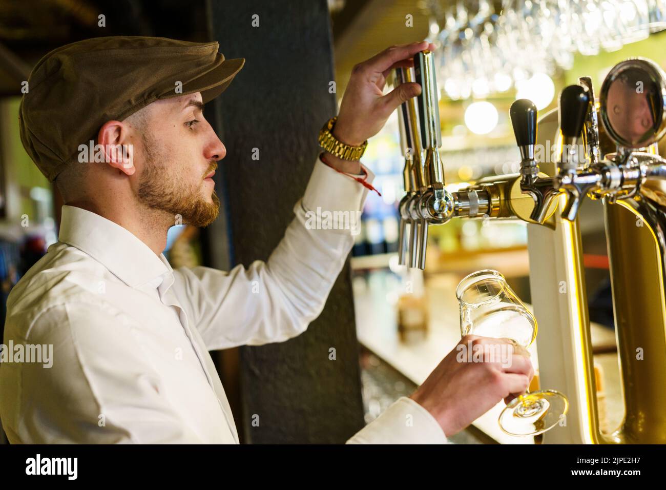 Male bartender pouring beer in beautiful pub Stock Photo - Alamy