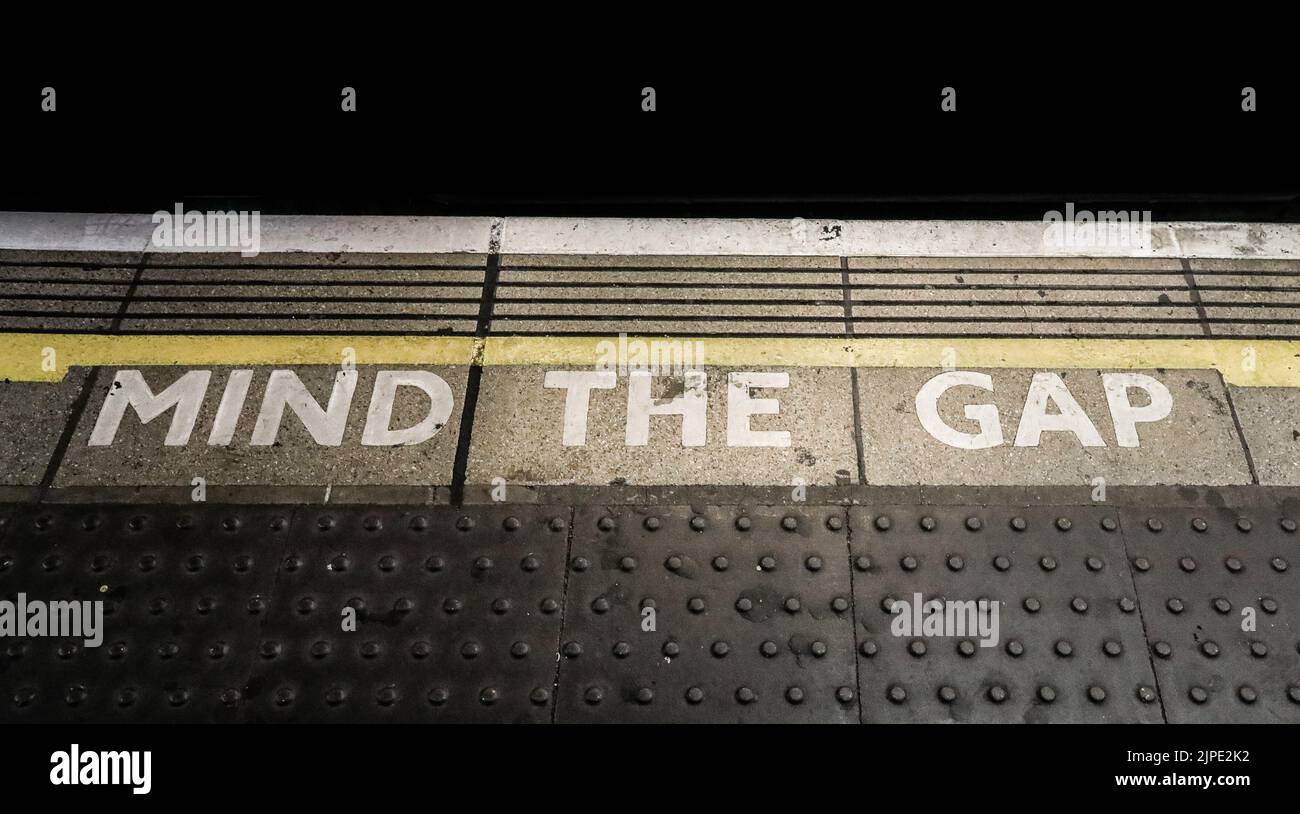 A 'Mind The Gap' notice painted on the platform of a London Underground ...