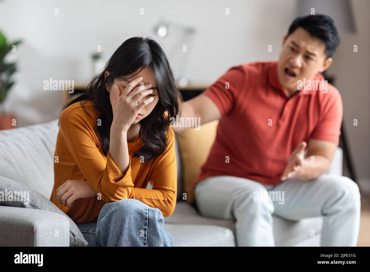 Emotional asian man shouting at his crying girlfriend Stock Photo - Alamy