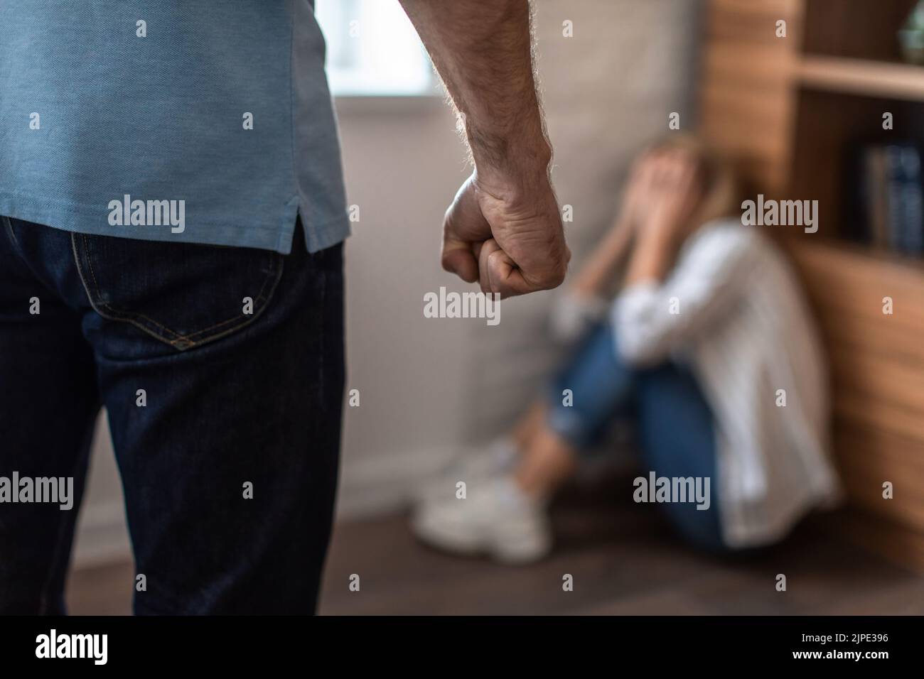 Scared crying mature caucasian woman covers face sits on floor and ...
