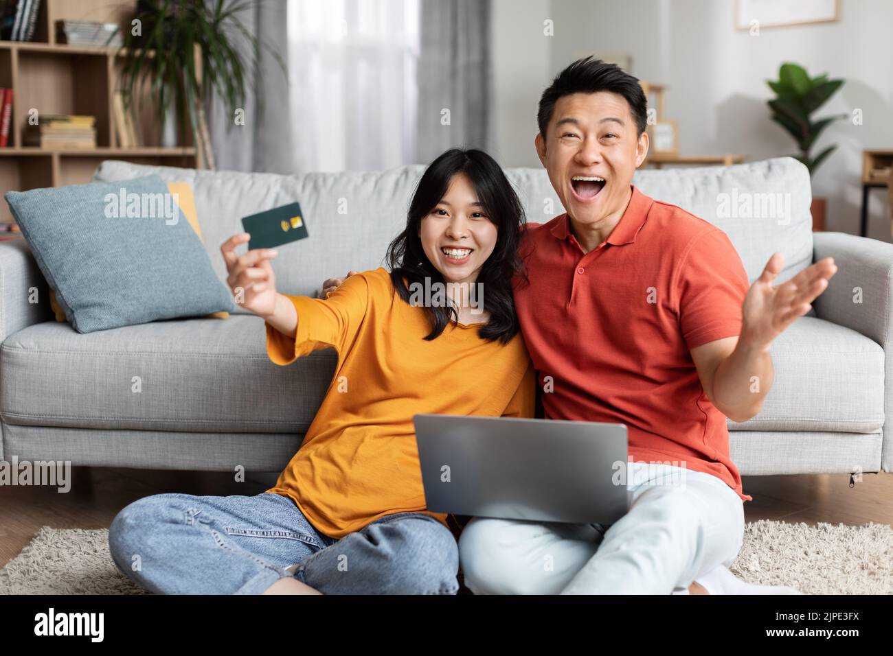Excited asian family shopping online at home, using computer Stock ...