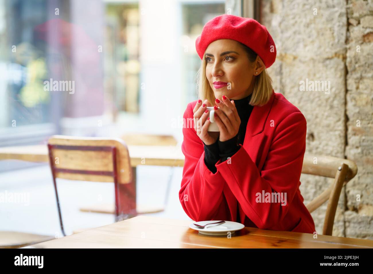 Fashionable woman with coffee in cafe Stock Photo - Alamy