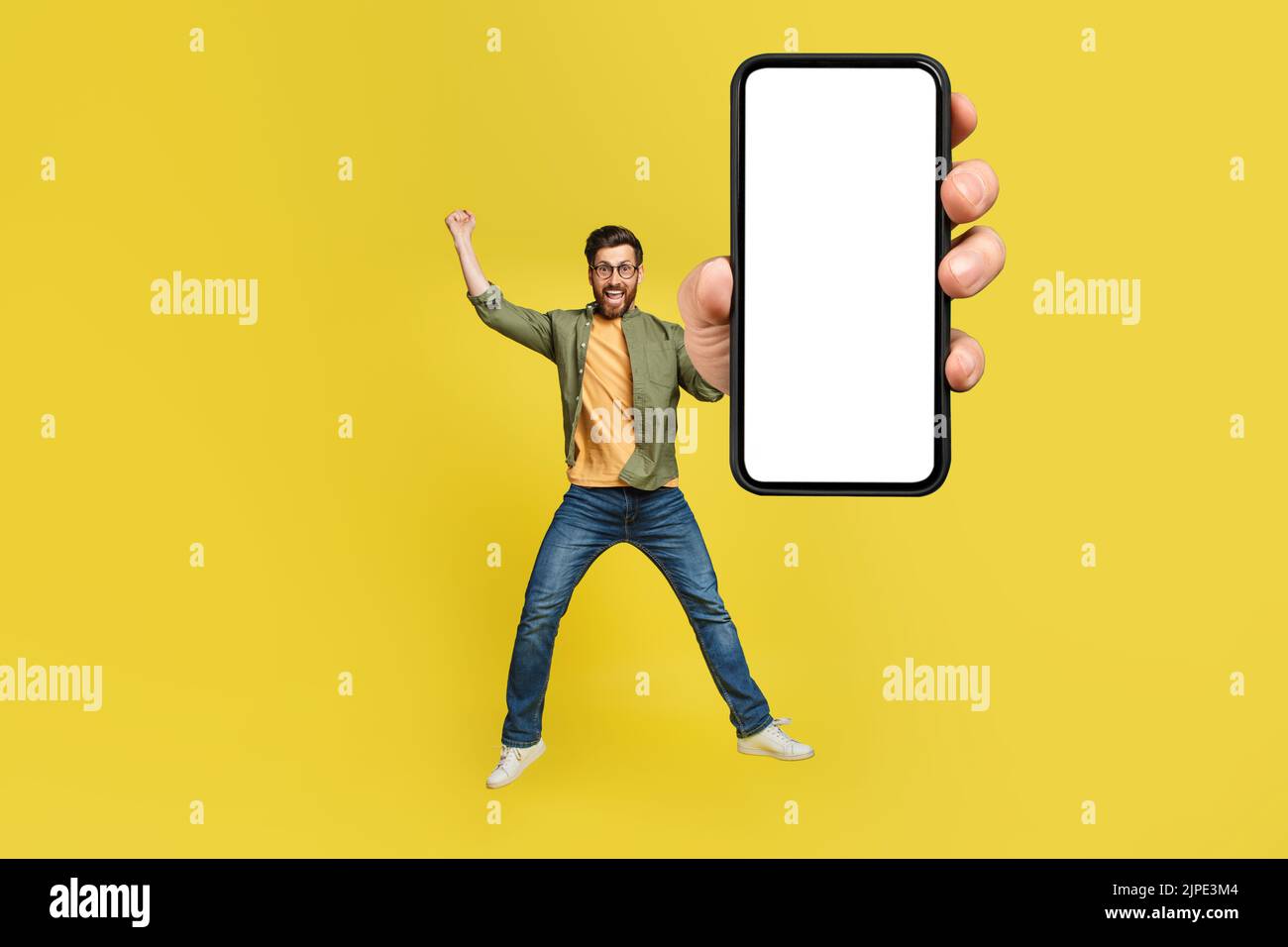 Full body length portrait of excited man jumping, making winner gesture ...