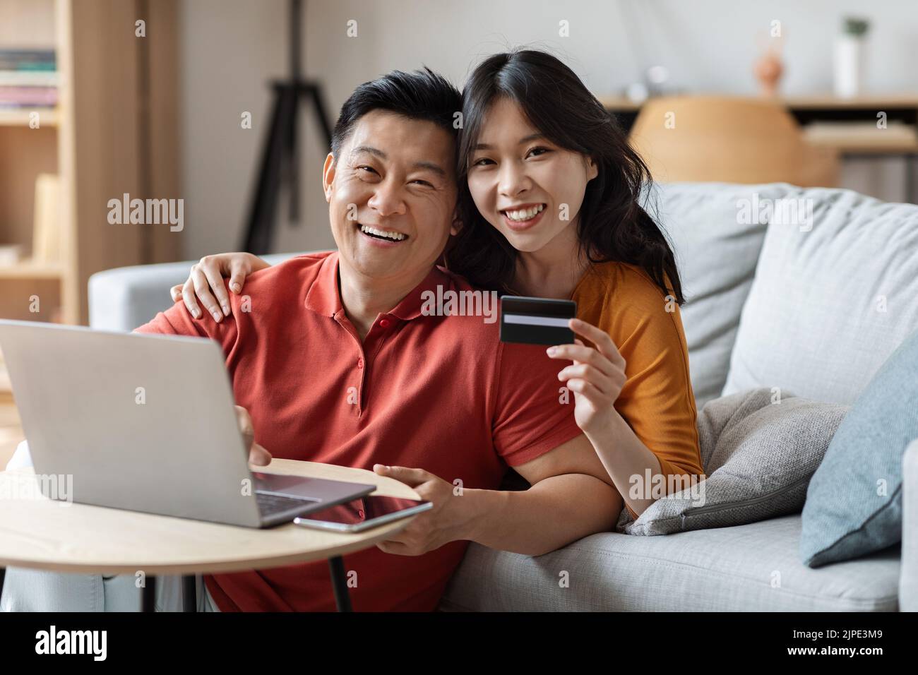 Happy asian husband and wife booking hotel online Stock Photo - Alamy