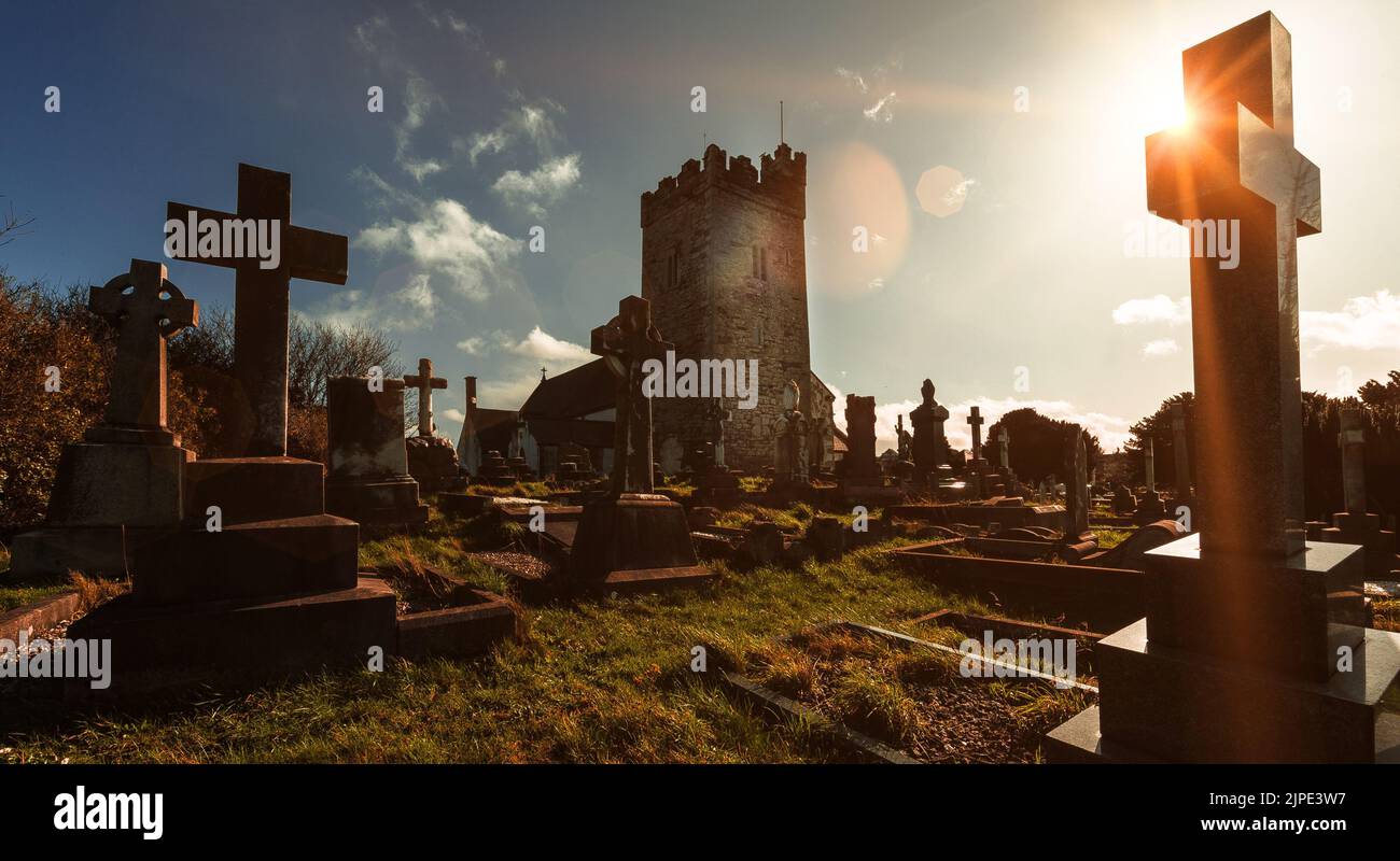 The sun shining over St Trillo's Parich Church and surrounding grave ...