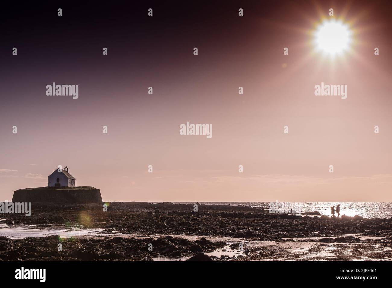 St Cwyfan's Church, known as 'The Church in the Sea' during sunset in ...