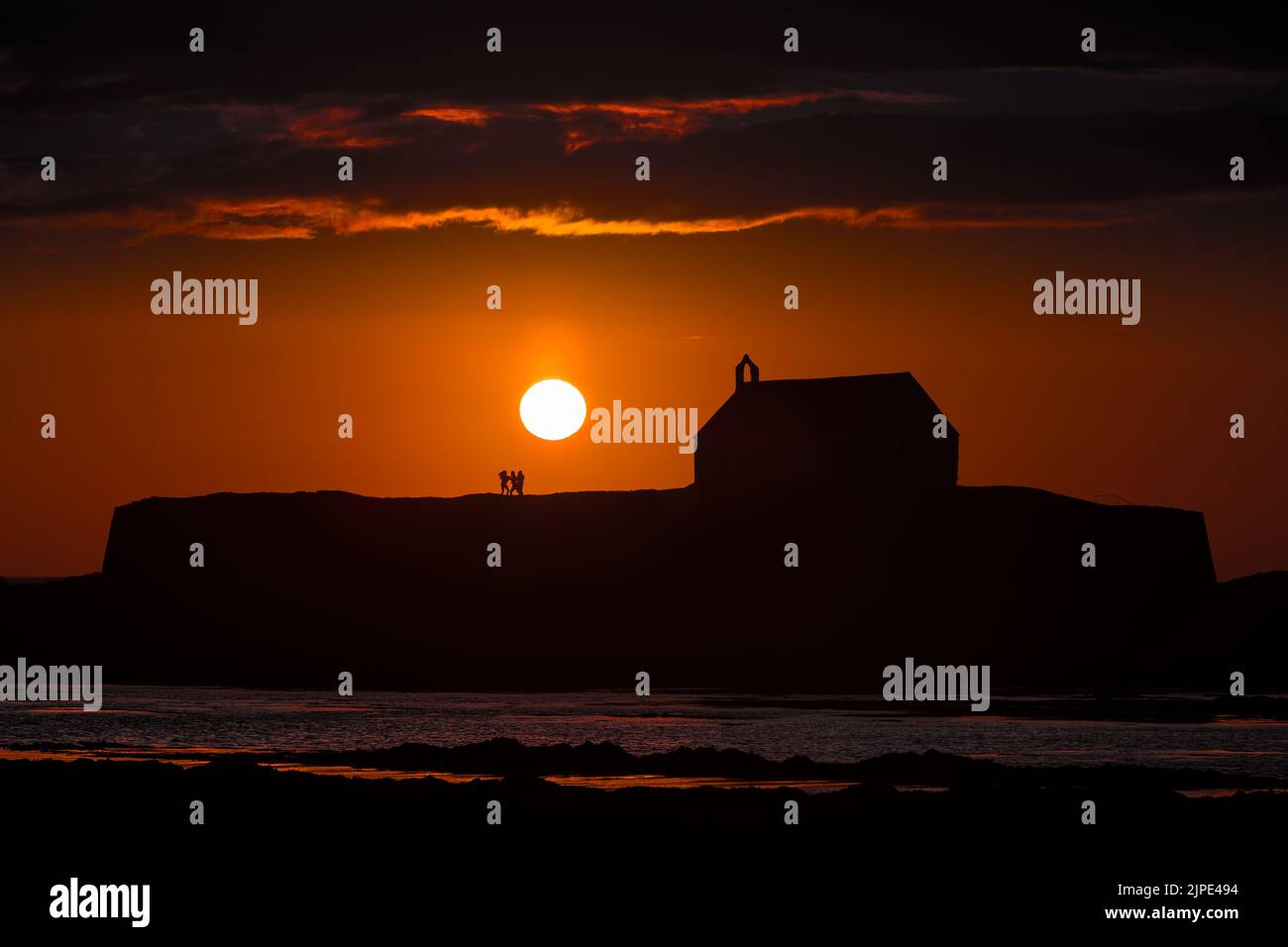 St Cwyfan's Church, known as 'The Church in the Sea' during sunset in ...