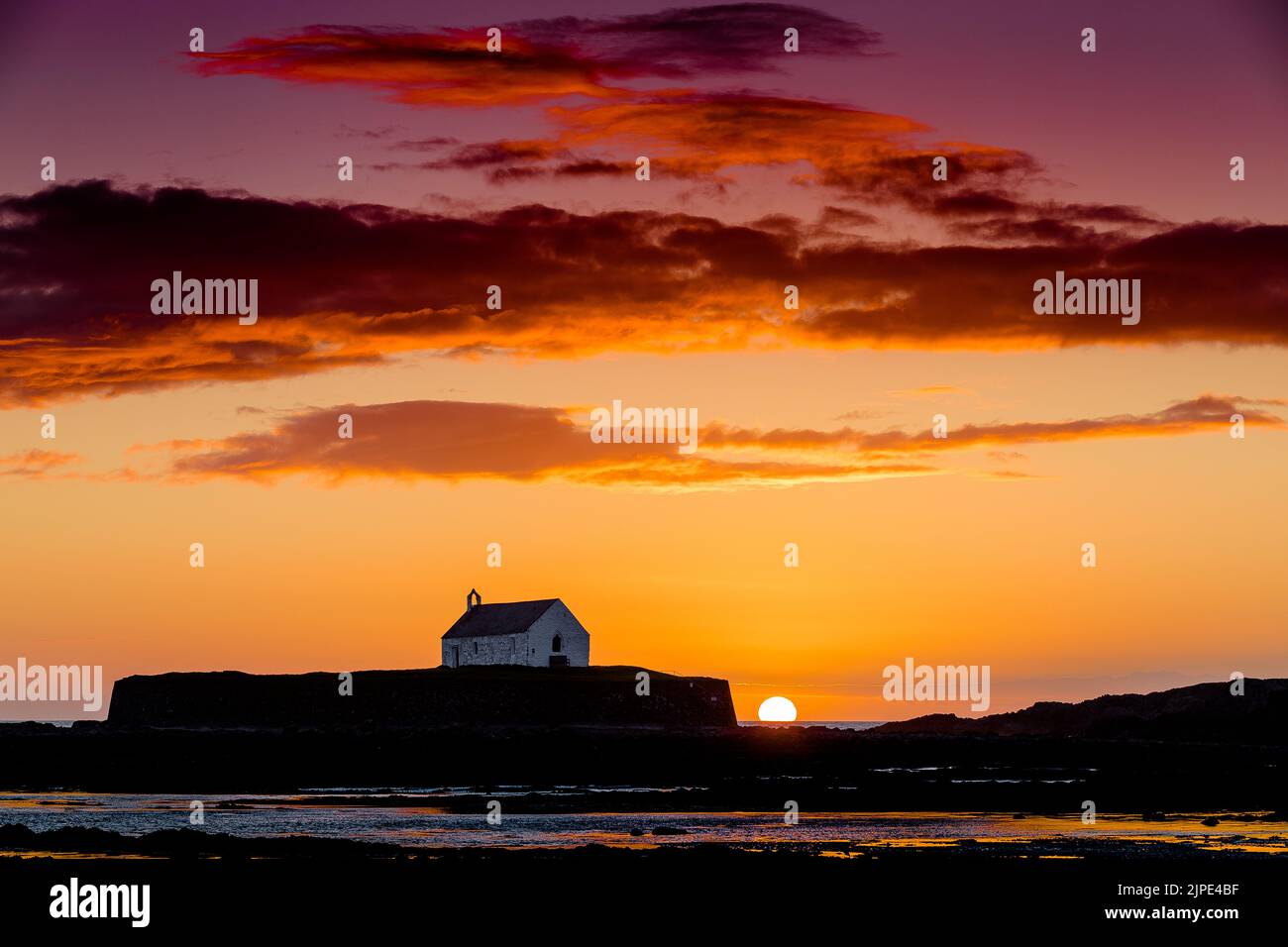 St Cwyfan's Church, known as 'The Church in the Sea' during sunset in ...