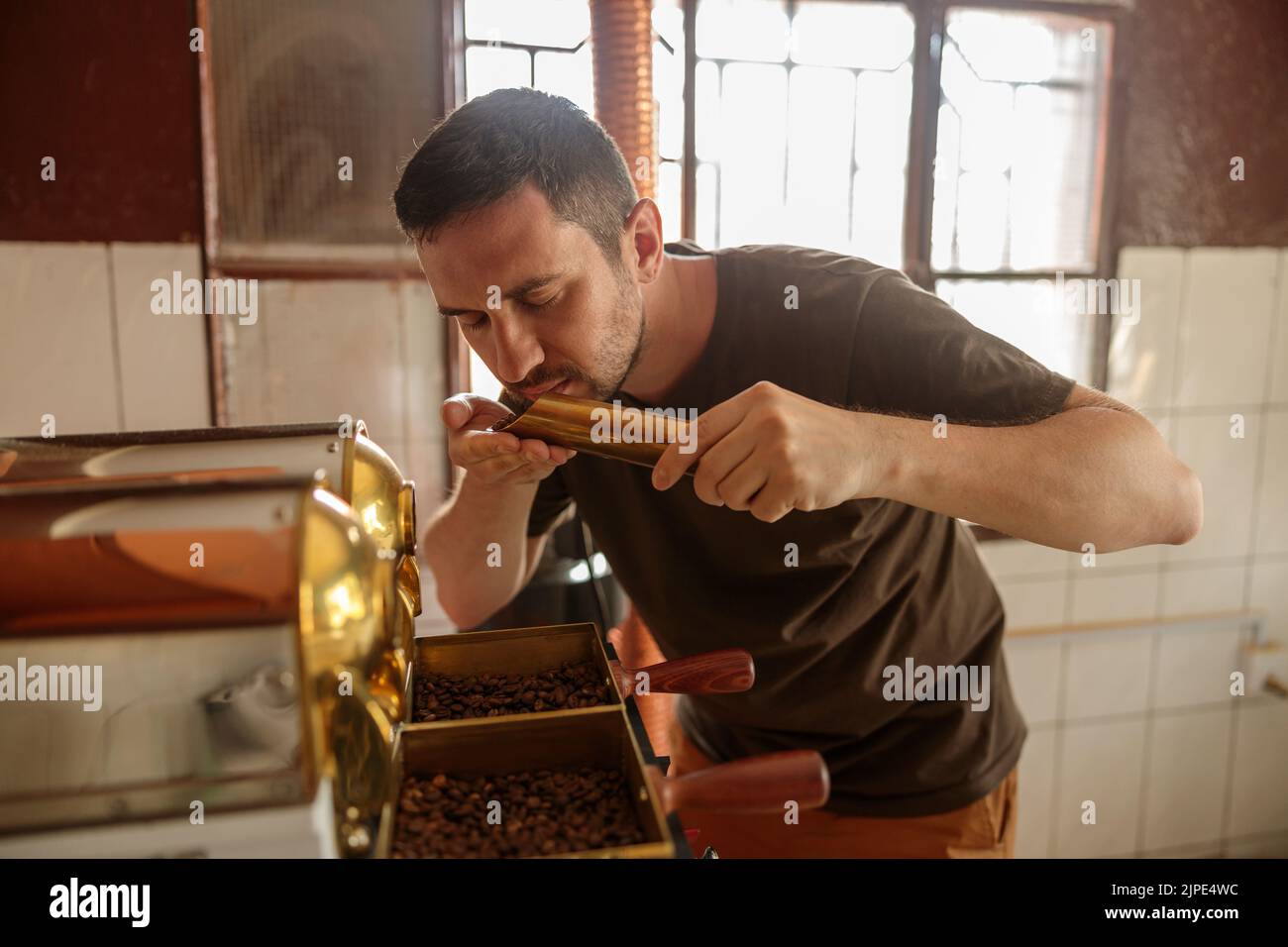 Grader closing his eyes and enjoying the aroma of coffee beans Stock ...