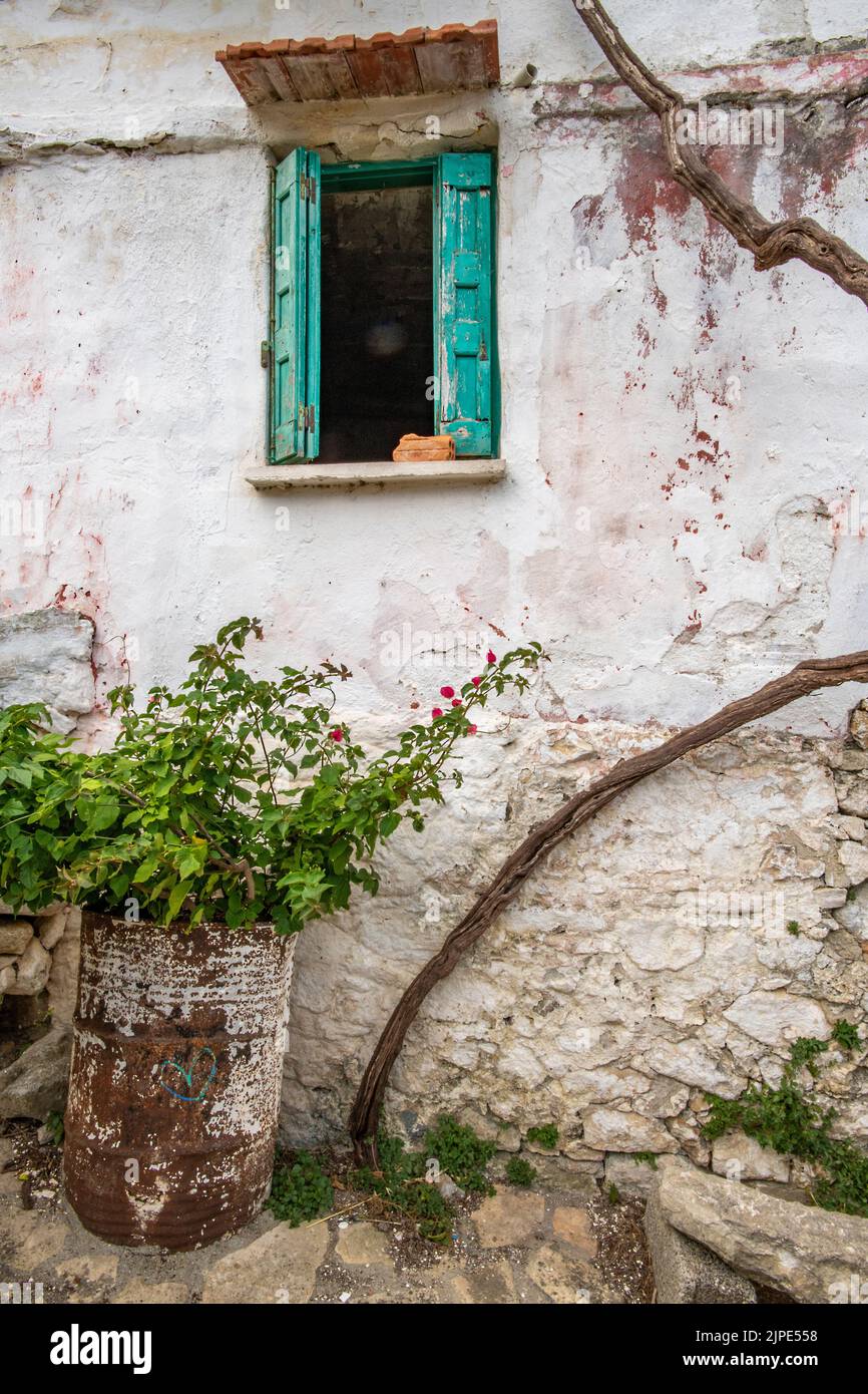 traditional greek home with green shutters and whitewashed walls with ...