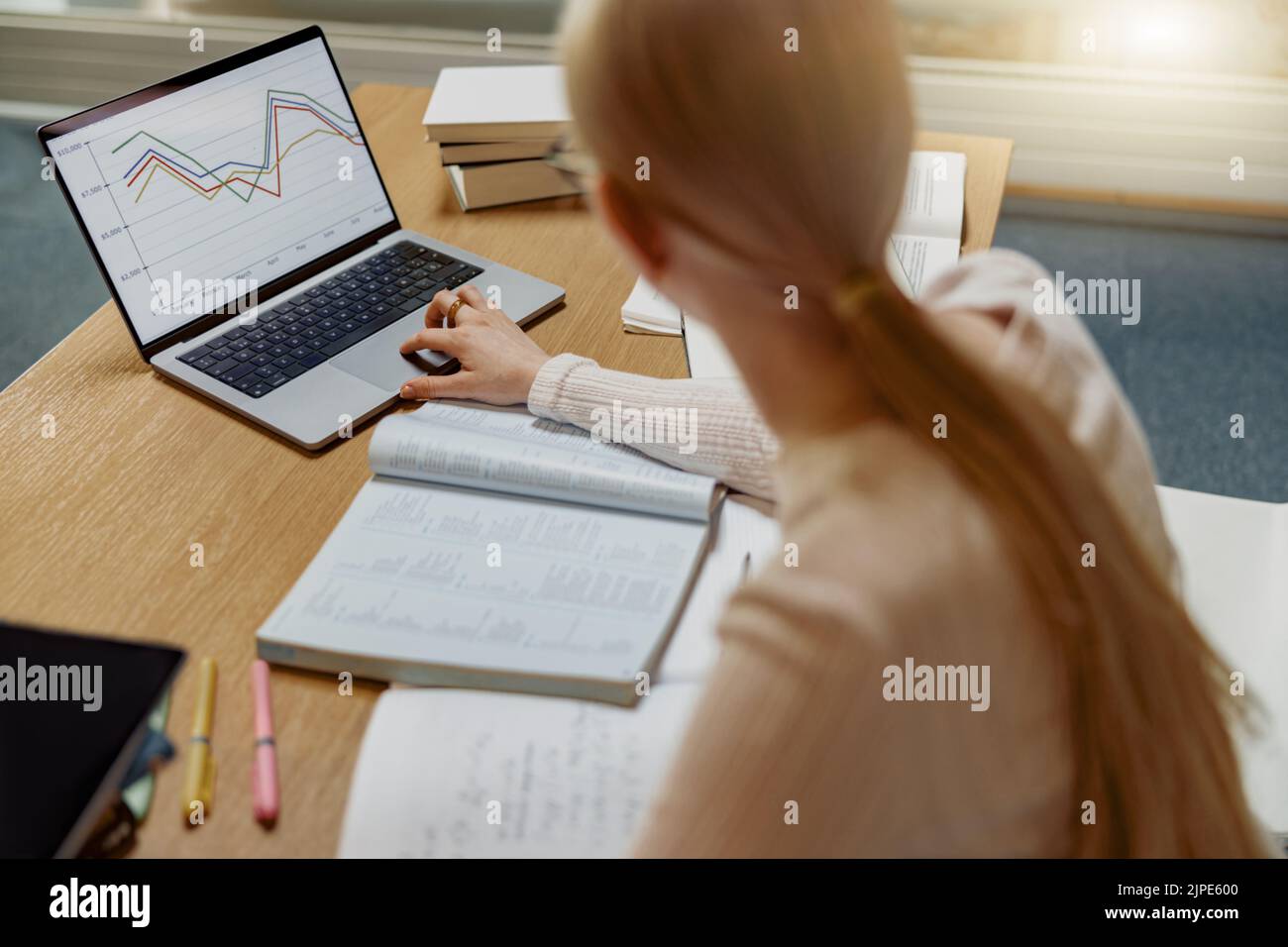 Young talented female student studying on laptop sit in university ...
