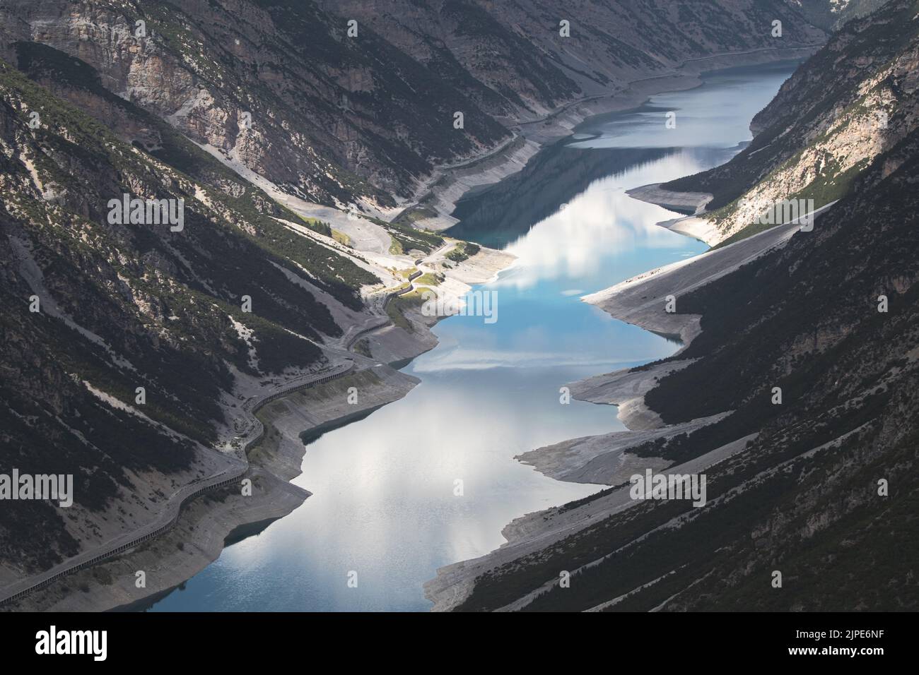 An aerial view of a beautiful narrow river between two mountains Stock ...