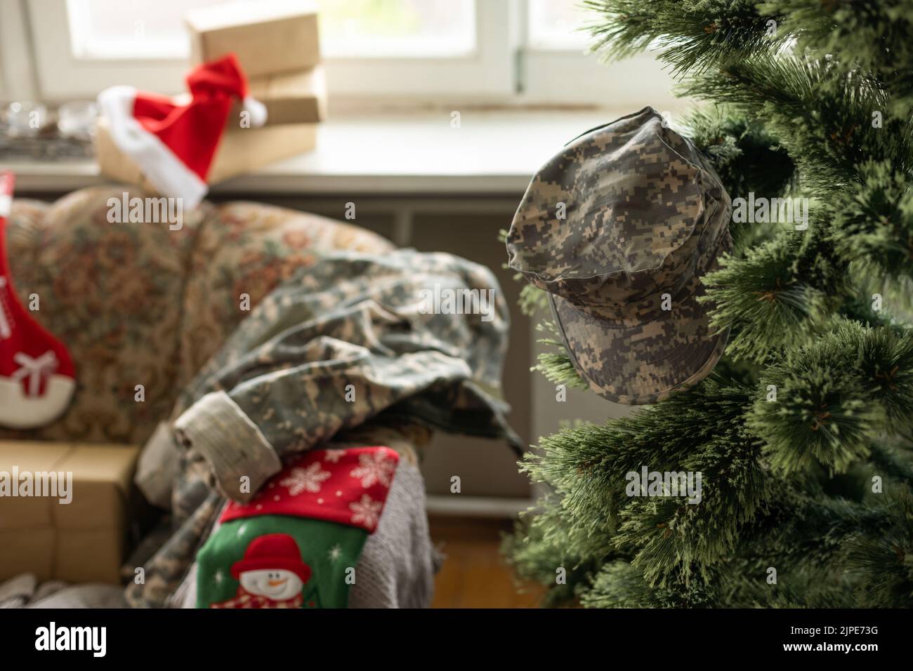 Christmas in the army. ball and gift box, military uniform, closeup ...