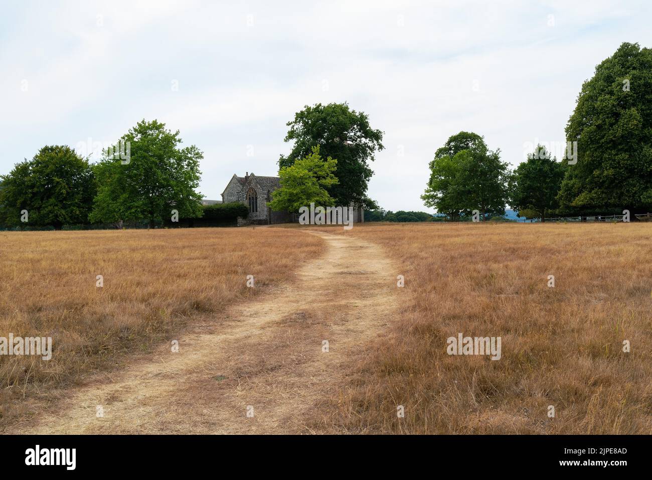 Parham House gardens with a path leading to St Peter's Church, Parham ...