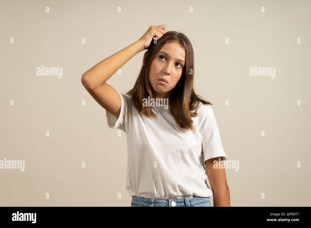 Portrait of brunette girl or young woman with puzzled, bewildered, dumb ...