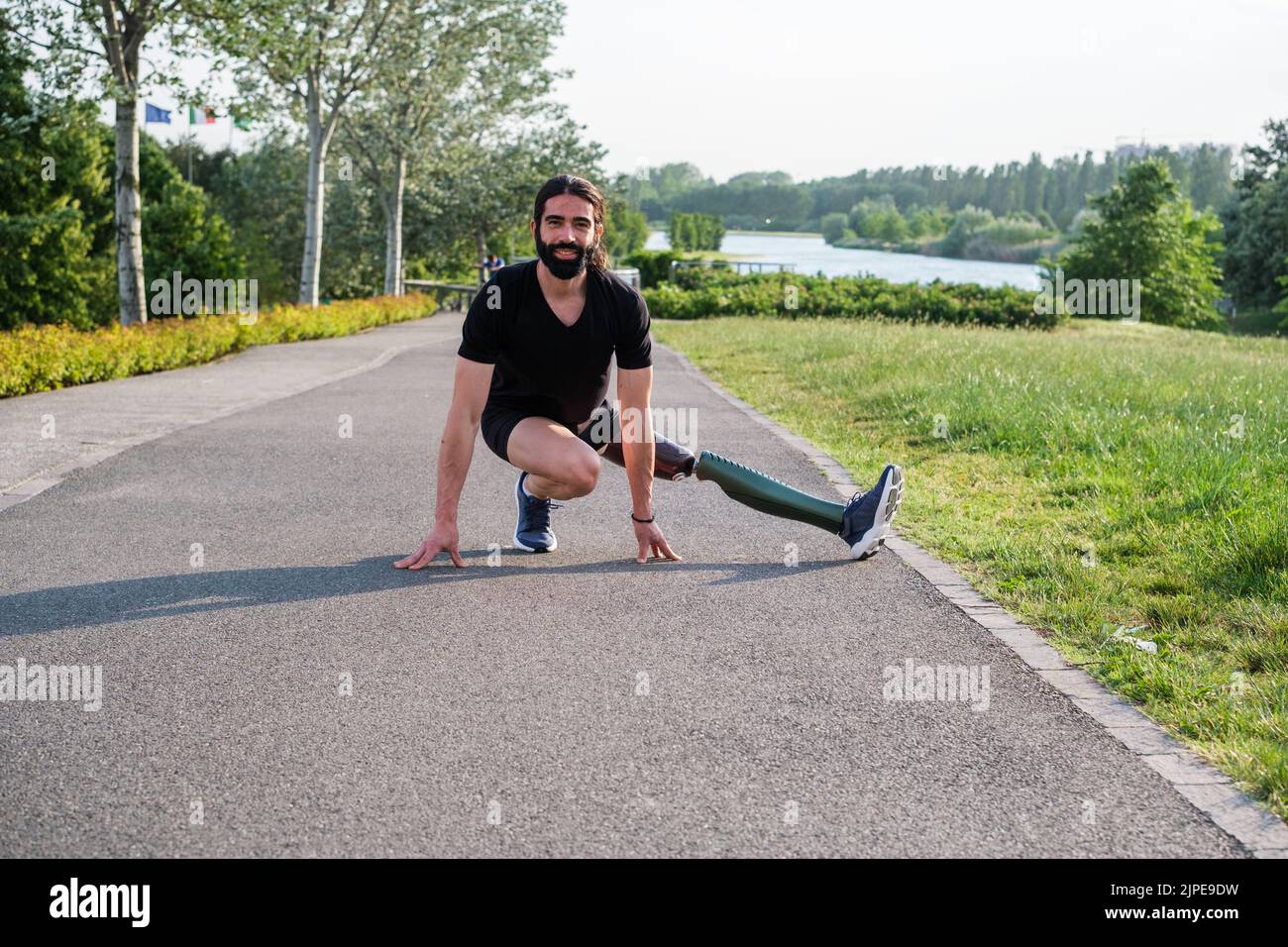Young man with prosthetic leg exercising in the park outdoors Stock ...