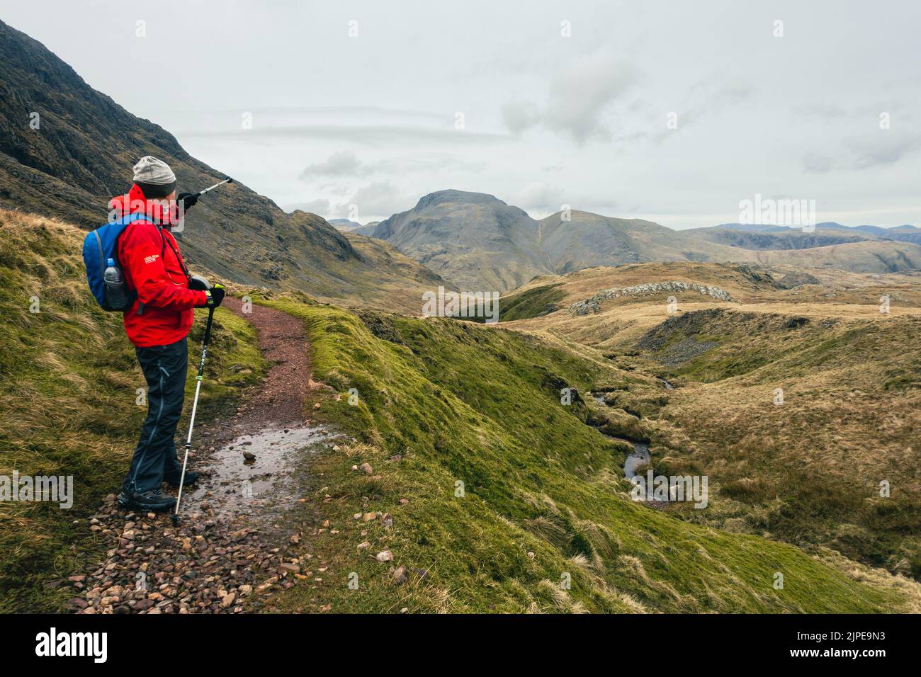 Hiker enjoying the views, pointing towards Great Gable and Green Gable ...