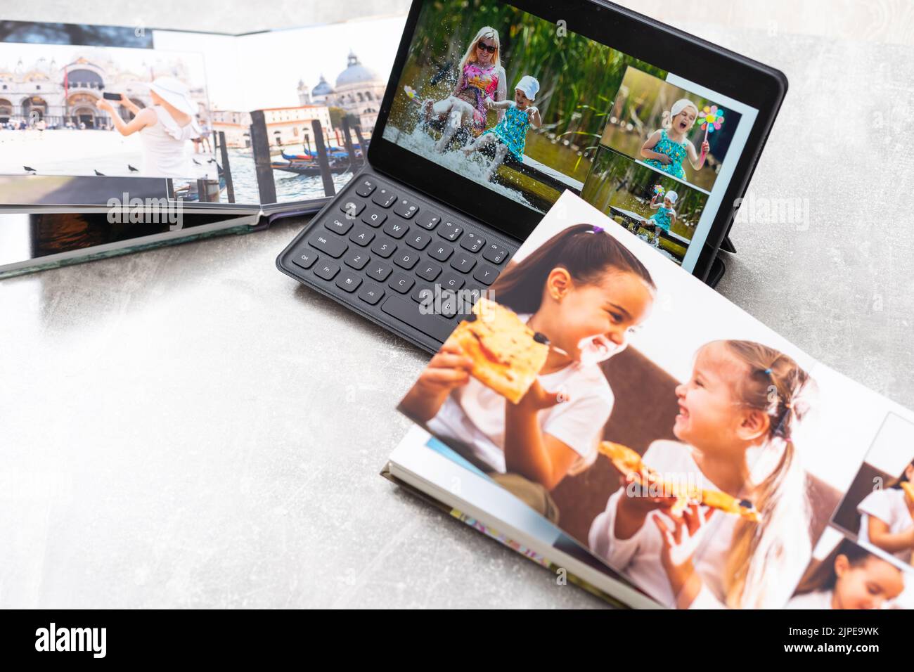 photobook album and tablet on the table Stock Photo - Alamy