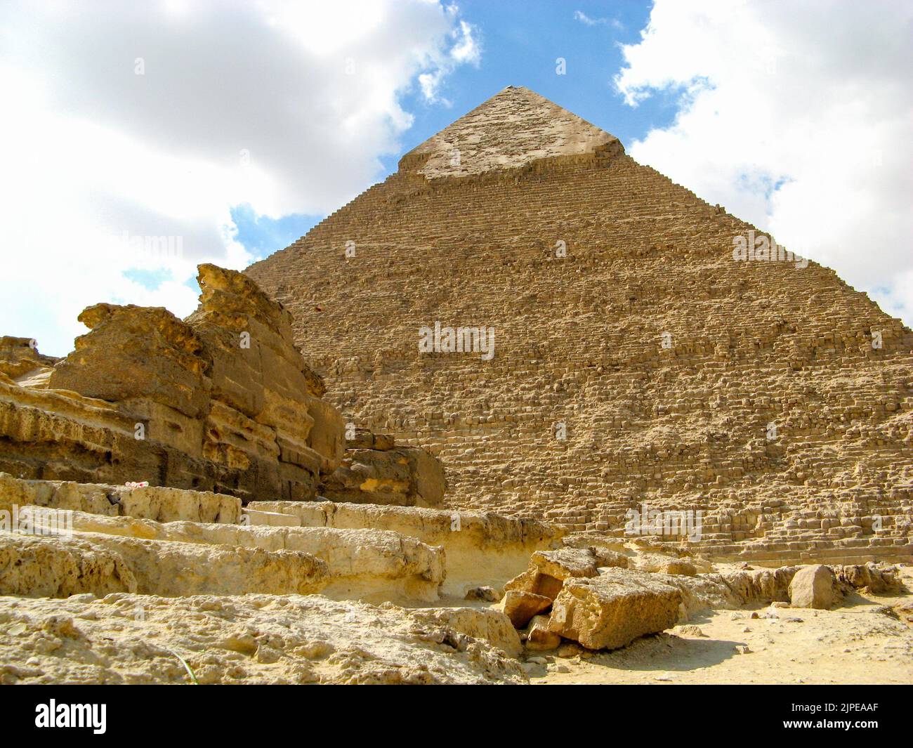 A low angle shot of the Great Pyramid of Giza under a cloudy sky Stock ...