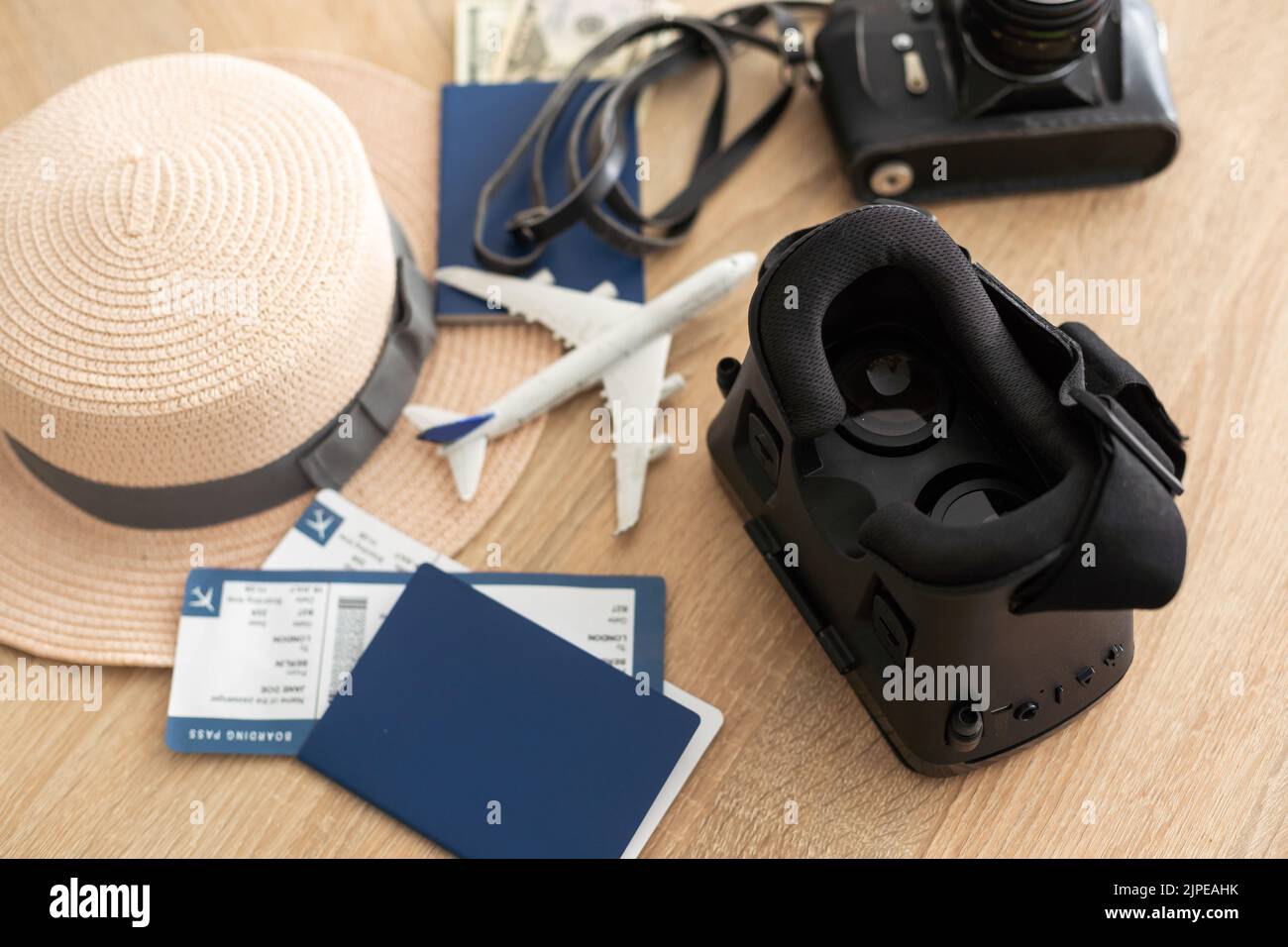 Flat lay composition of vr headset, travel accessories on a wooden ...