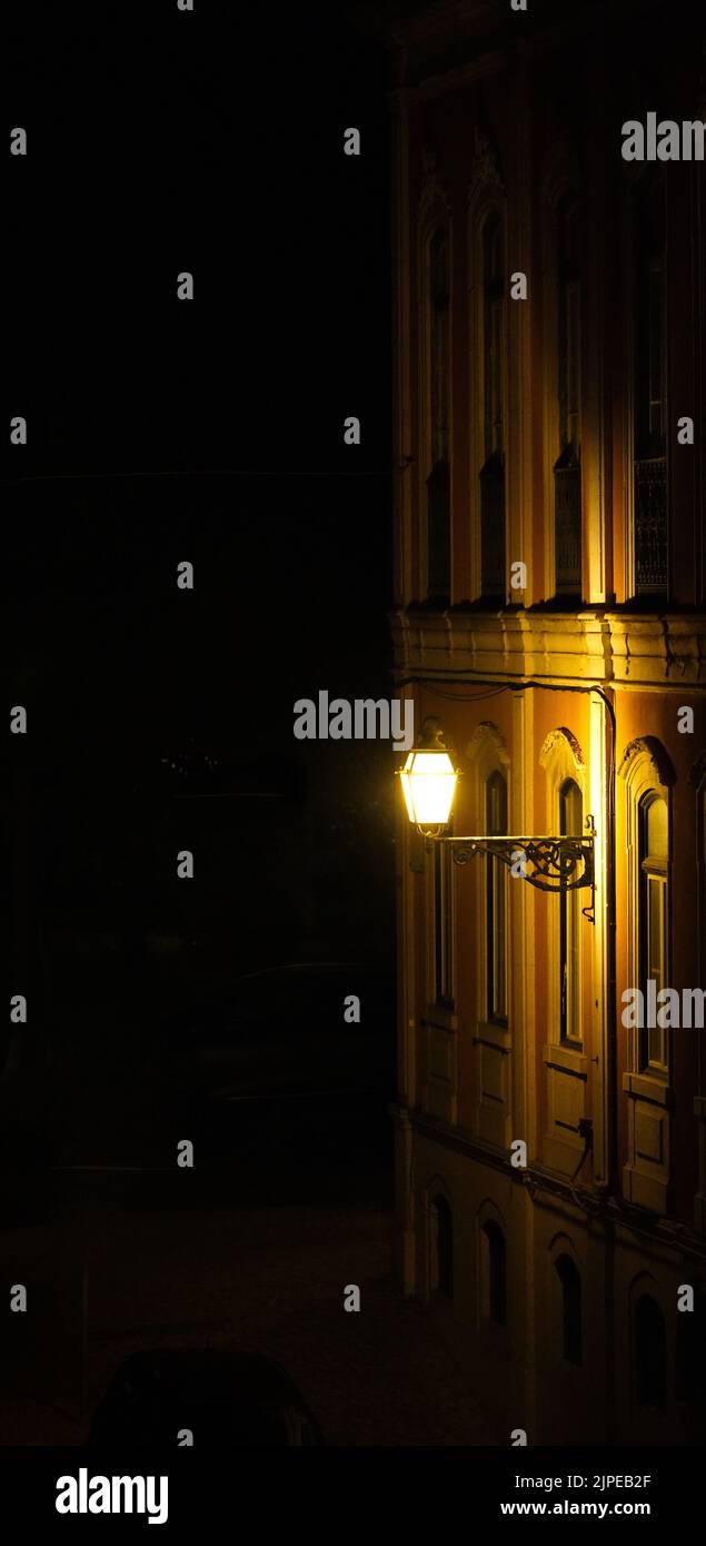 Lisbon, Portugal, gas light at night in a street in the old part of ...
