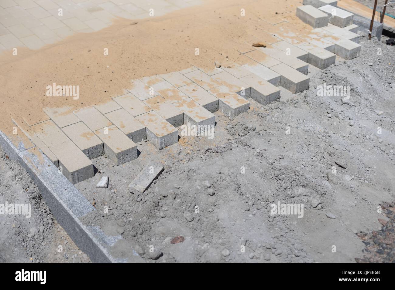 Stone blocks laying is on sand base. Sidewalk device Stock Photo - Alamy