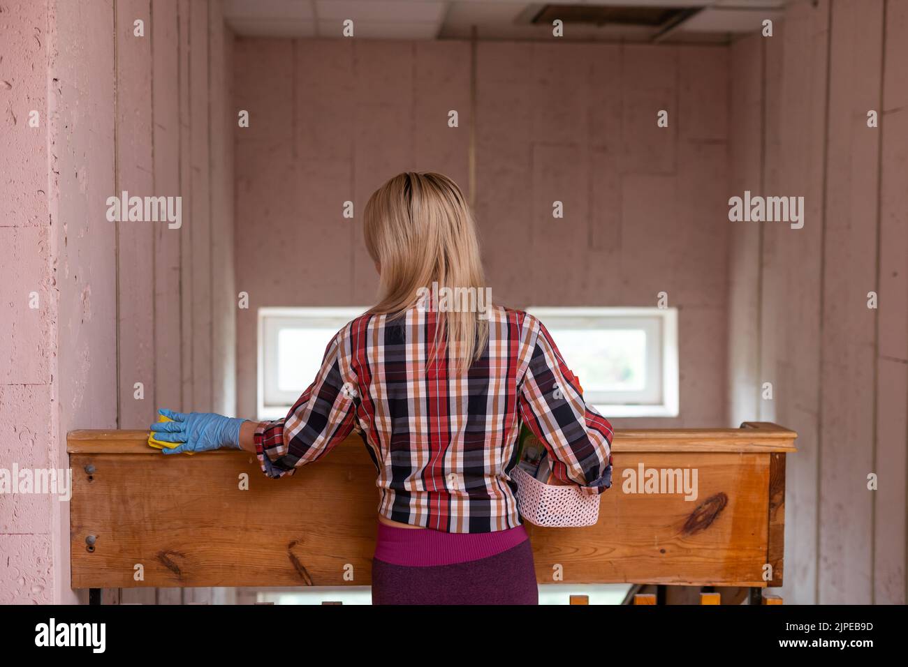 Woman cleaning and wiping with microfiber cloth. Woman doing chores at ...