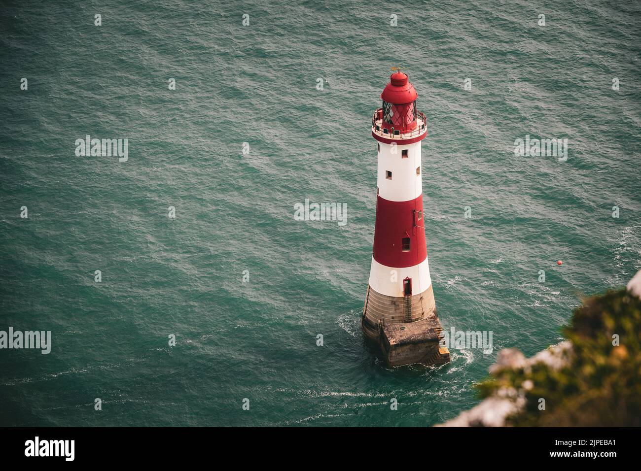 A lighthouse along the White Cliffs of Dover near Beachy Head in ...