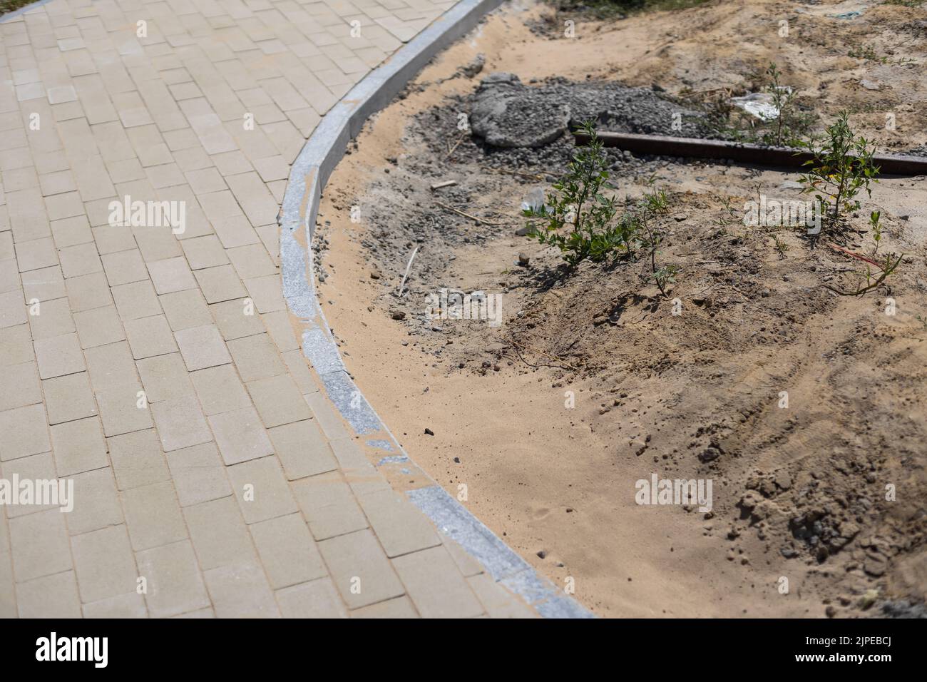 Stone blocks laying is on sand base. Sidewalk device Stock Photo - Alamy