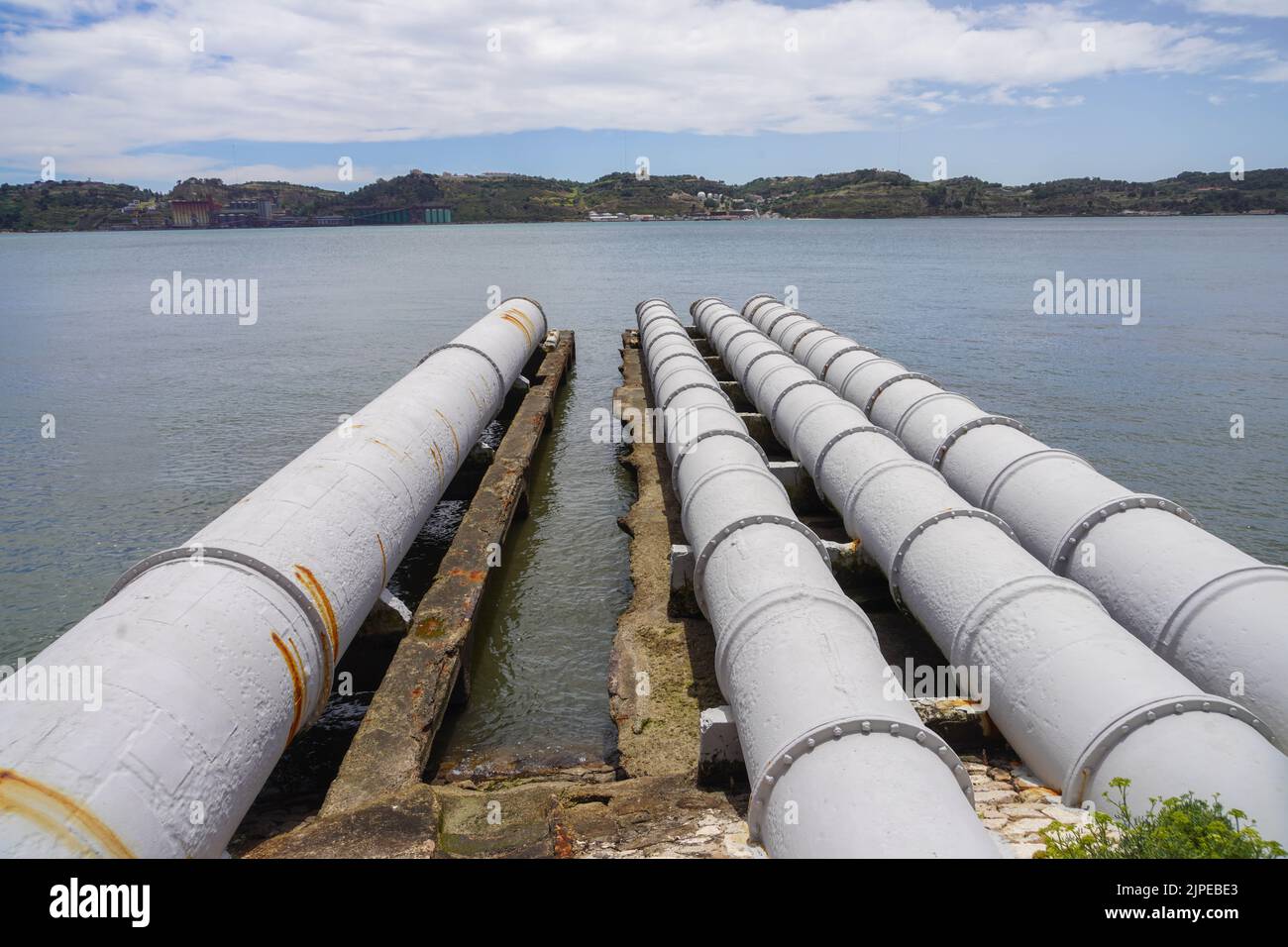 Pipelines leading into a river Stock Photo - Alamy