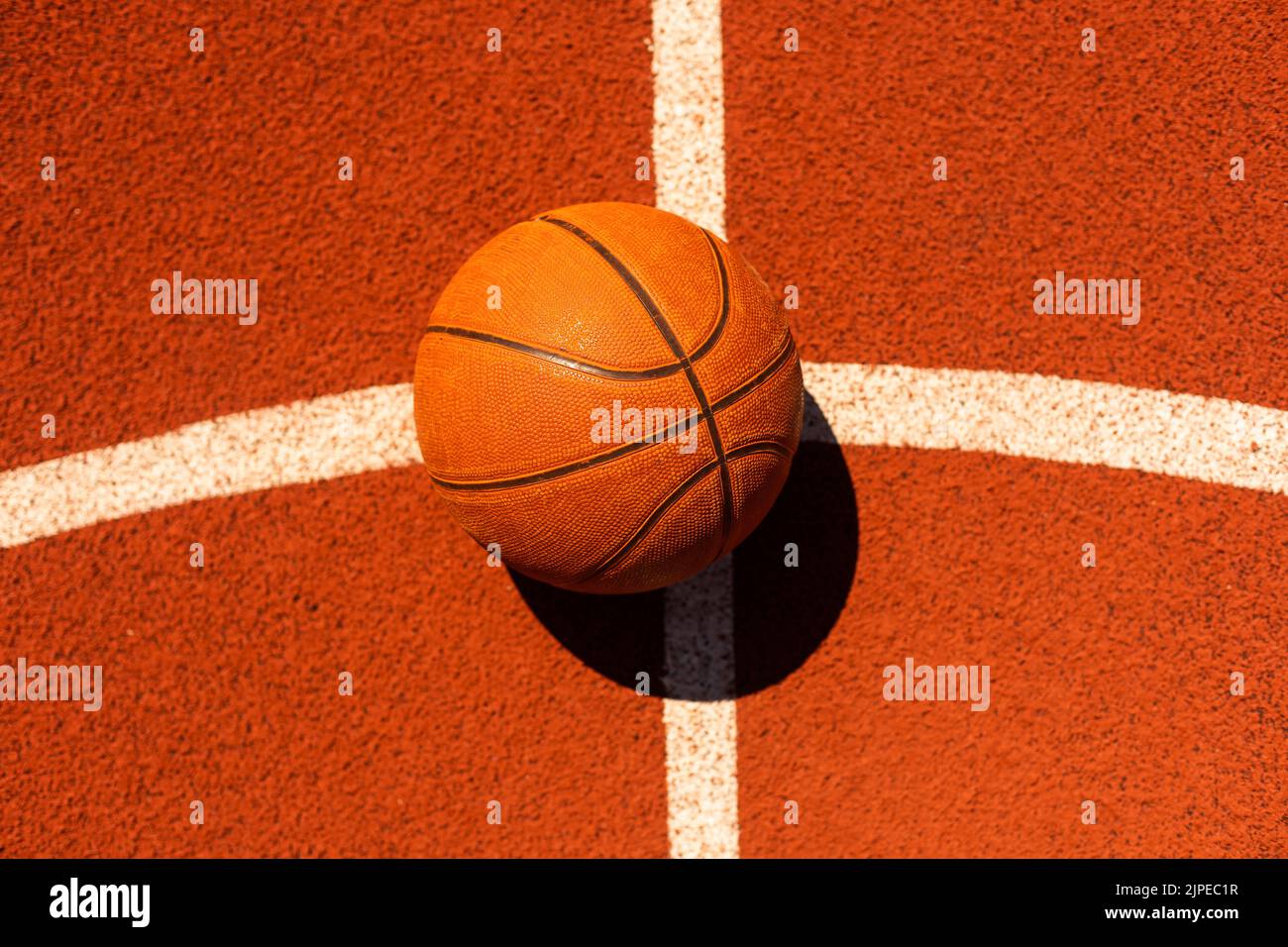 Top view orange ball for basketball lying on the rubber sport court ...