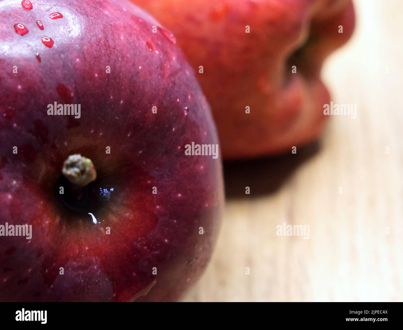 Wet red apple, close-up shot. Place for text Stock Photo - Alamy