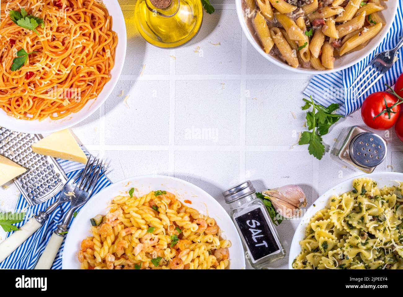 Set of pasta with different sauces on white tiled background. Spaghetti ...