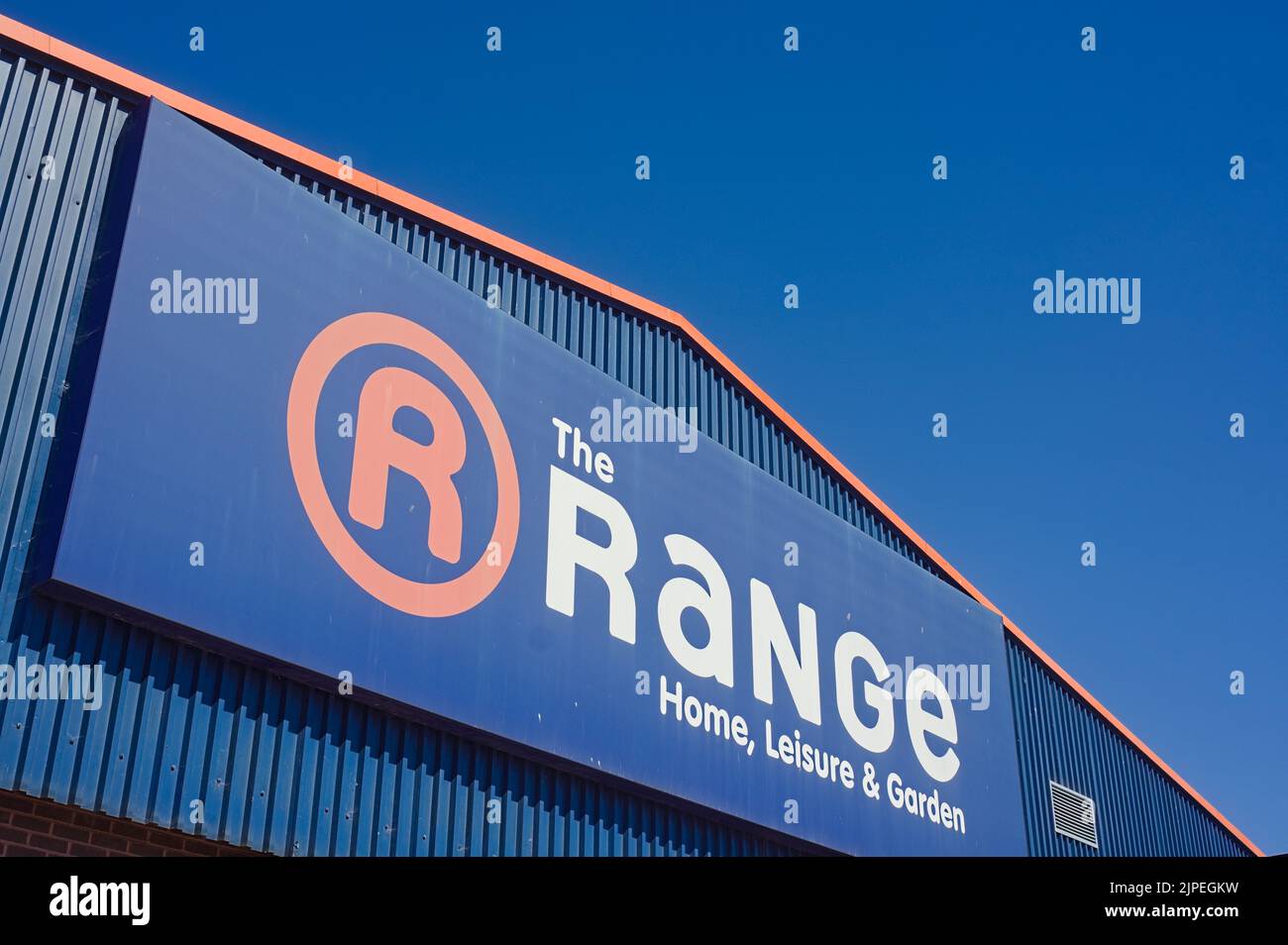Looking up at The Range store sign against a blue sky Stock Photo - Alamy