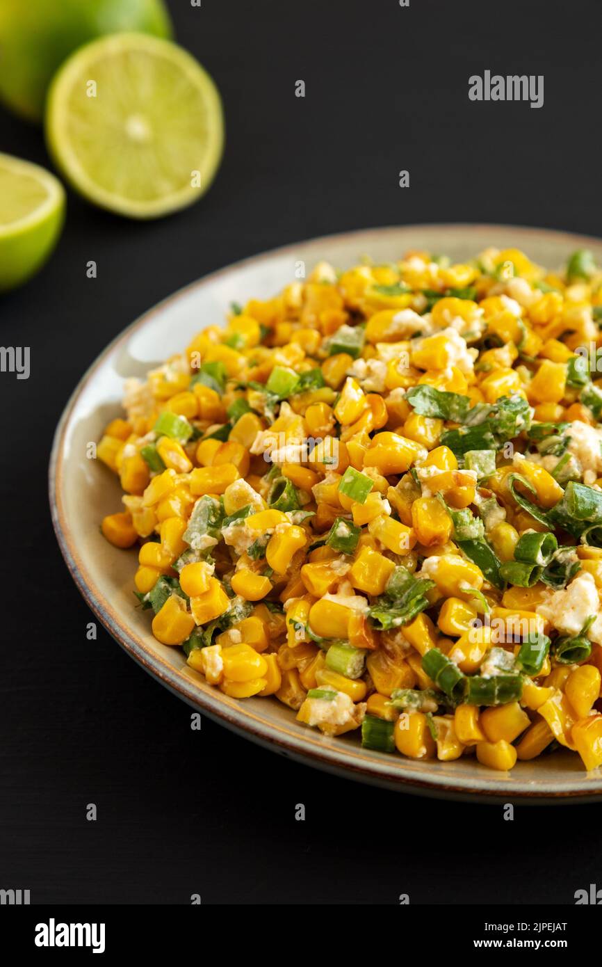 Homemade Mexican Street Corn Esquites on a Plate on a black background ...