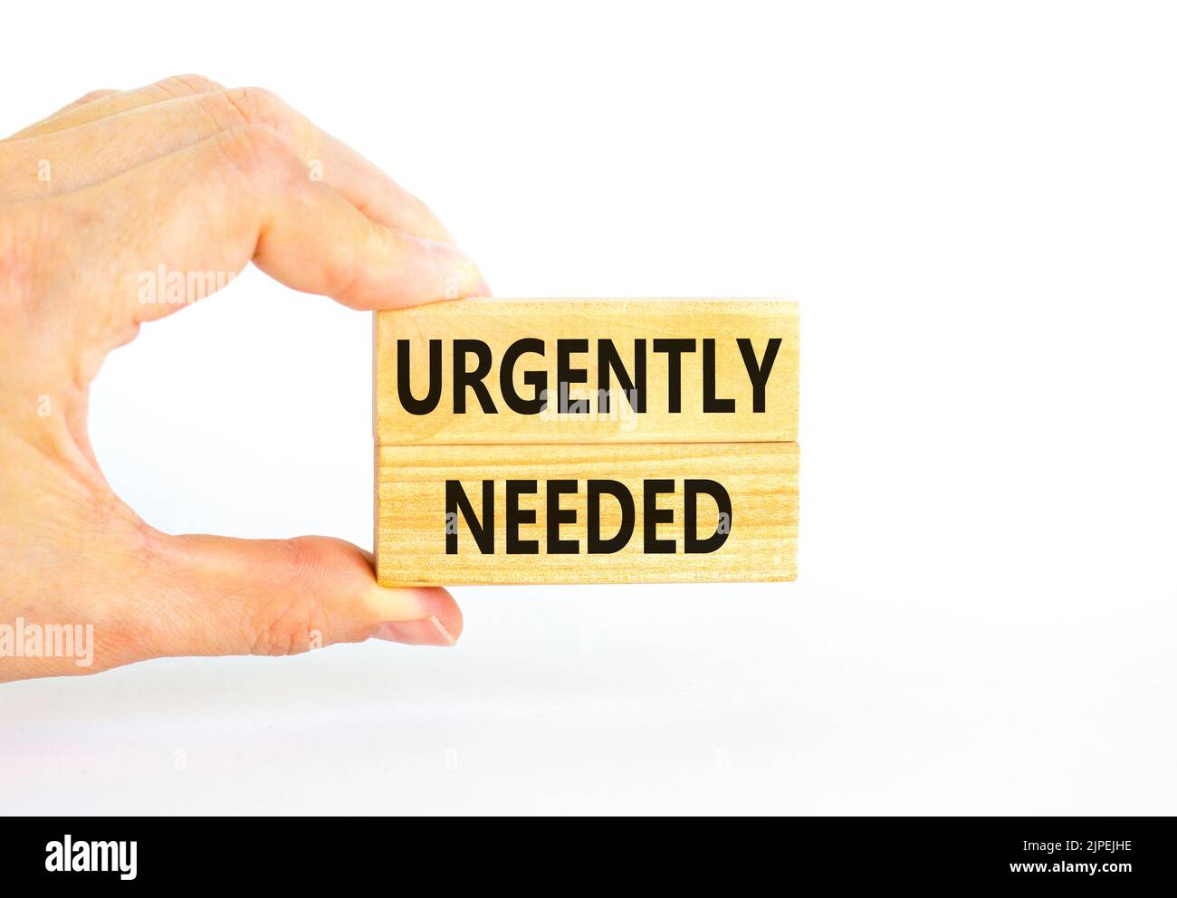 Urgently needed symbol. Concept words Urgently needed on wooden blocks ...