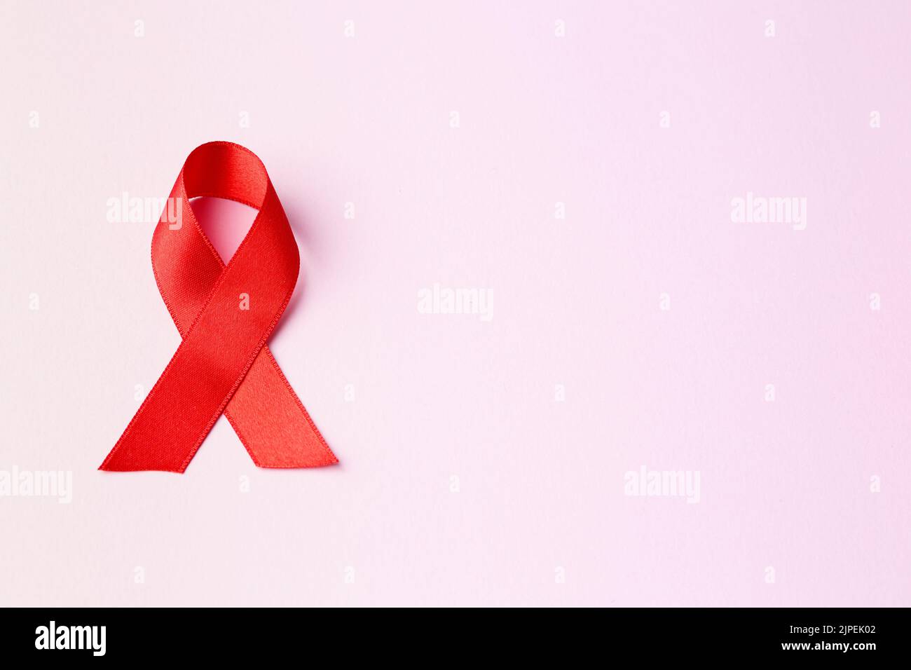 Red ribbon. Cancer control symbol Stock Photo - Alamy
