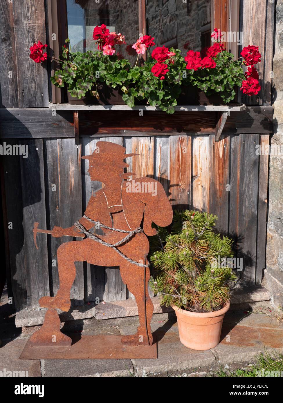 The image is of a metal cut out depicting a mountaineer at the Franz Senn Hut in the Stubai Alps ...