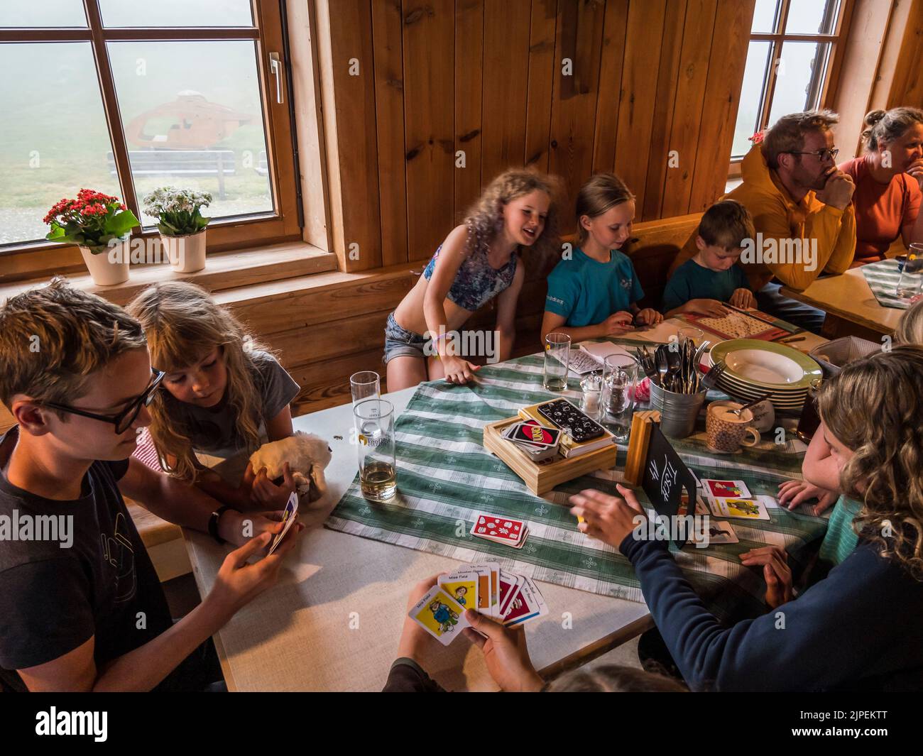 The image is of young people relaxing at the Franz Senn Hut in the ...