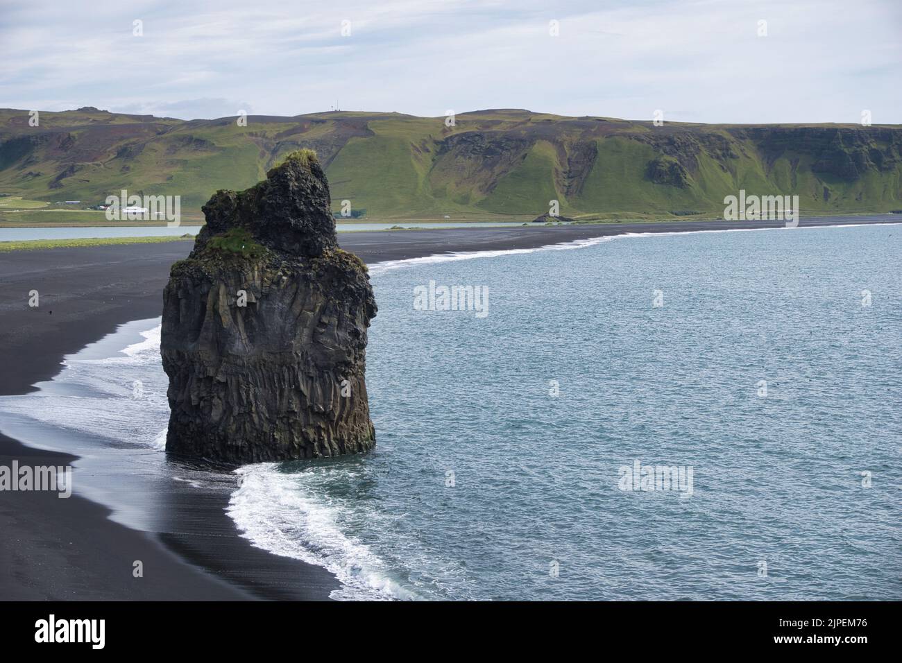 Reynisfjara - black beach in Iceland, single rock and cliffs Stock ...