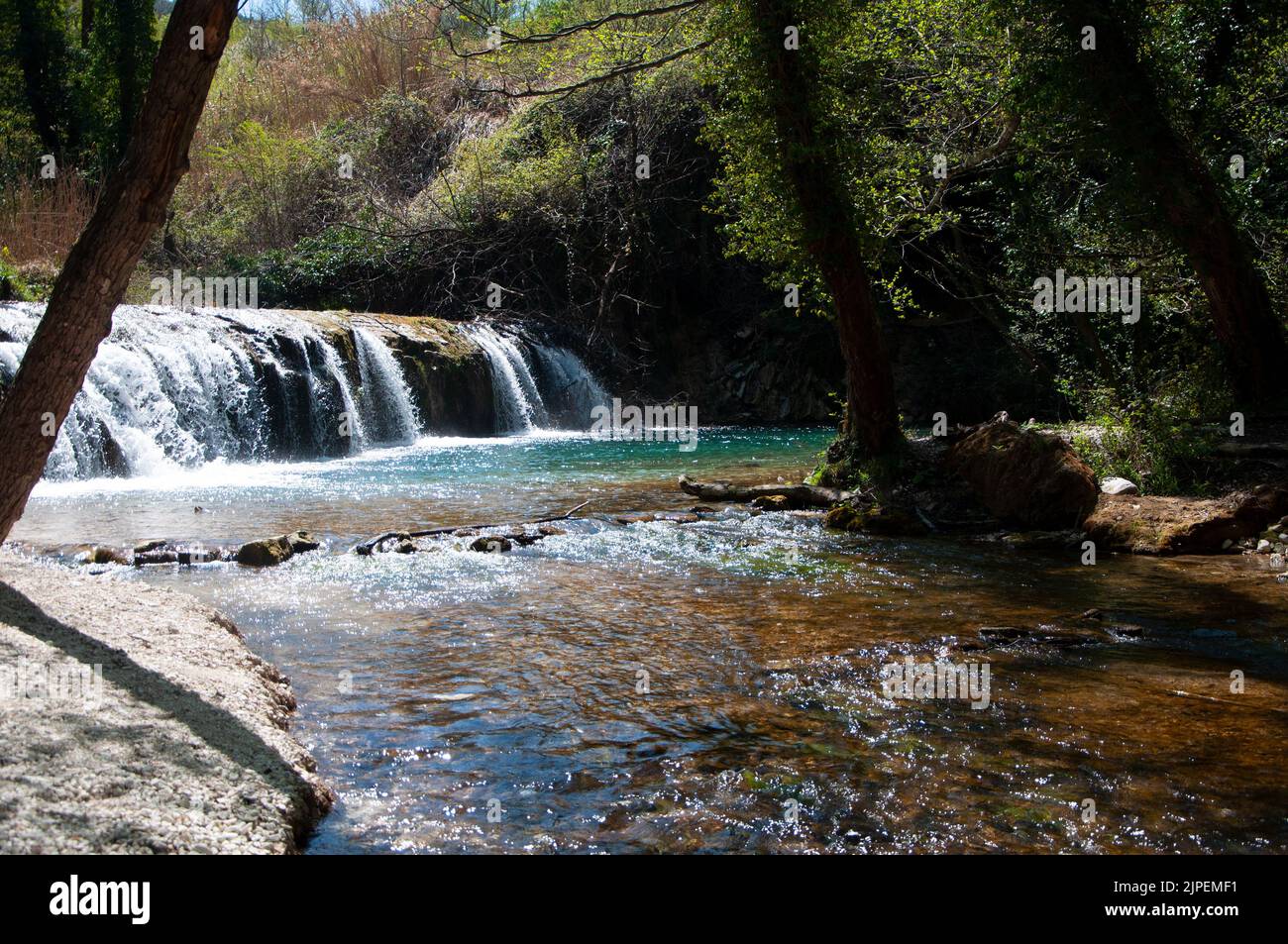 The water flowing from the cascade of the river in the forest of Marche ...