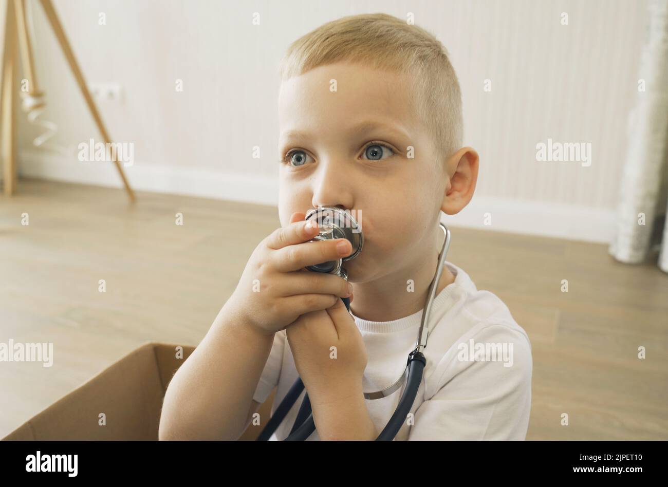 The boy plays with a stethoscope, blows into it. Children's games Stock ...
