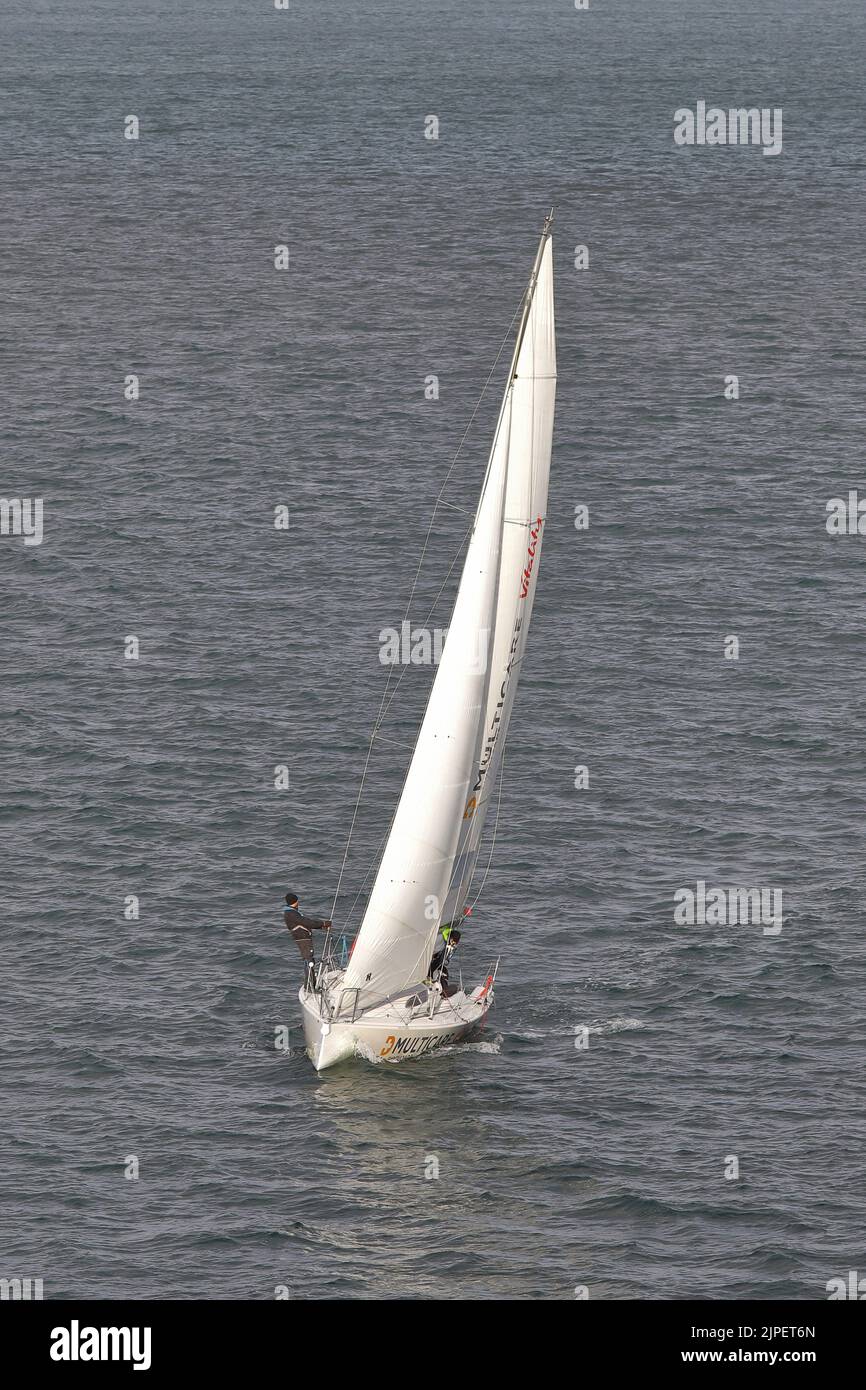 A yacht sails on the River Tagus off the Lisbon coastline in Portugal ...