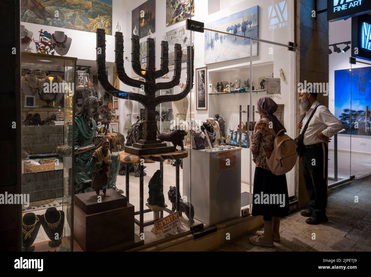 An ultra orthodox Jewish couple look at items displayed in a souvenir ...
