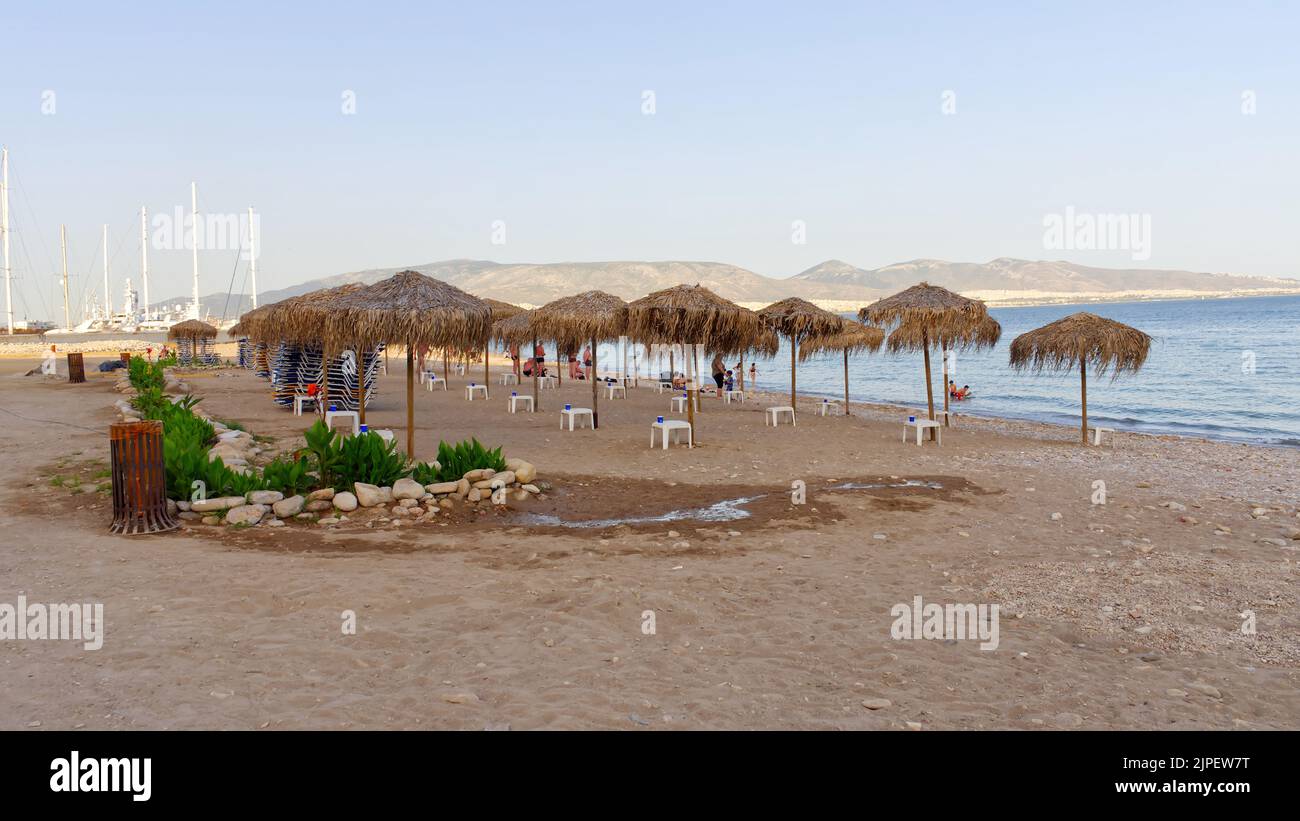 Greece Empty beach. chairs and closed sun umbrellas on the beach in ...